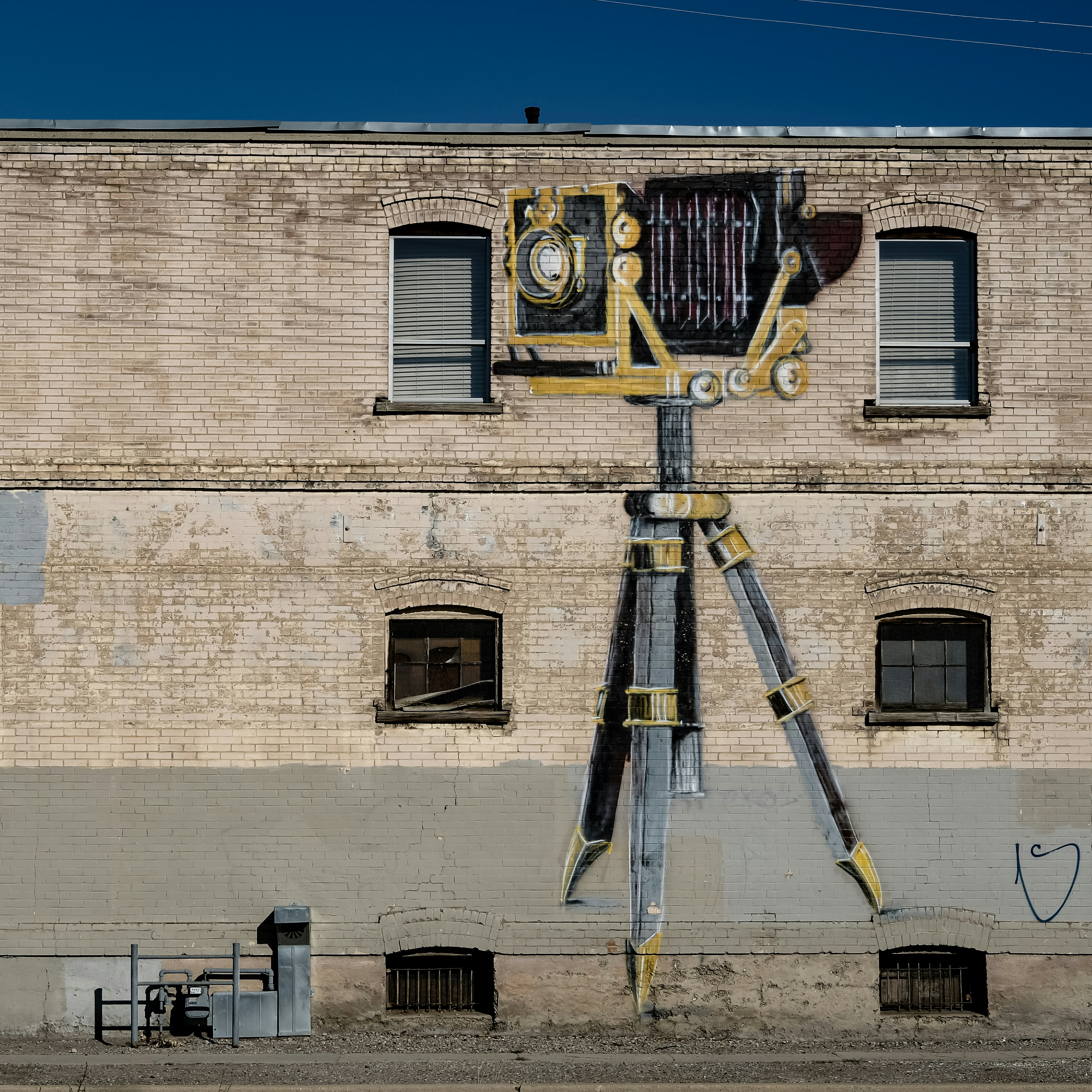 A building with a giant camera on top of it photo – Free Brick Image on ...
