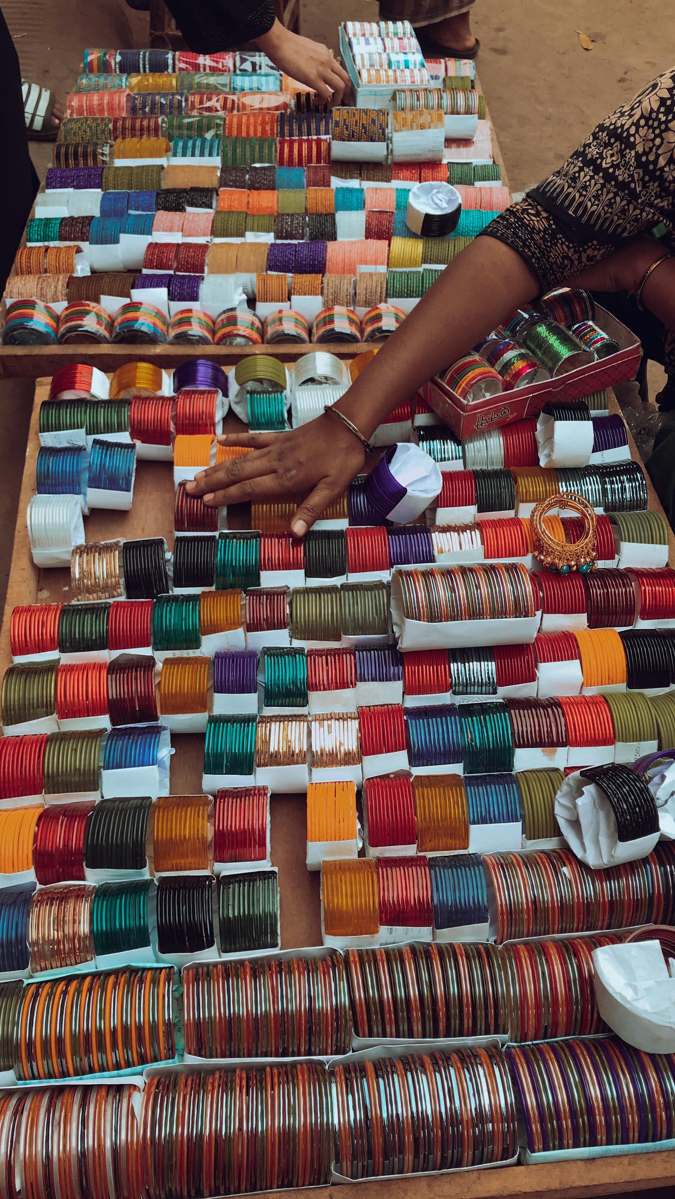 A table topped with lots of different types of bracelets photo – Free ...