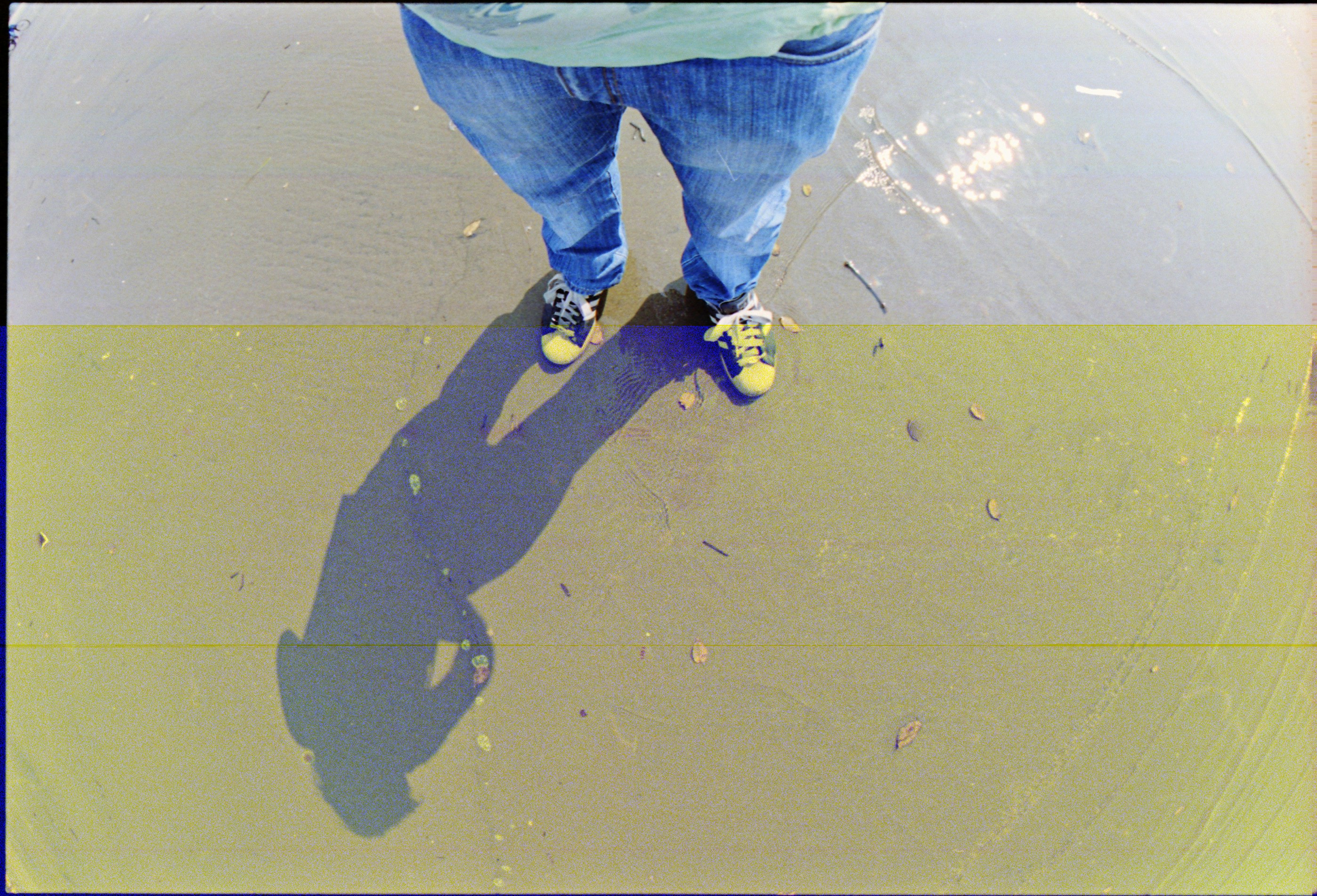 a person standing on a skateboard on a sidewalk