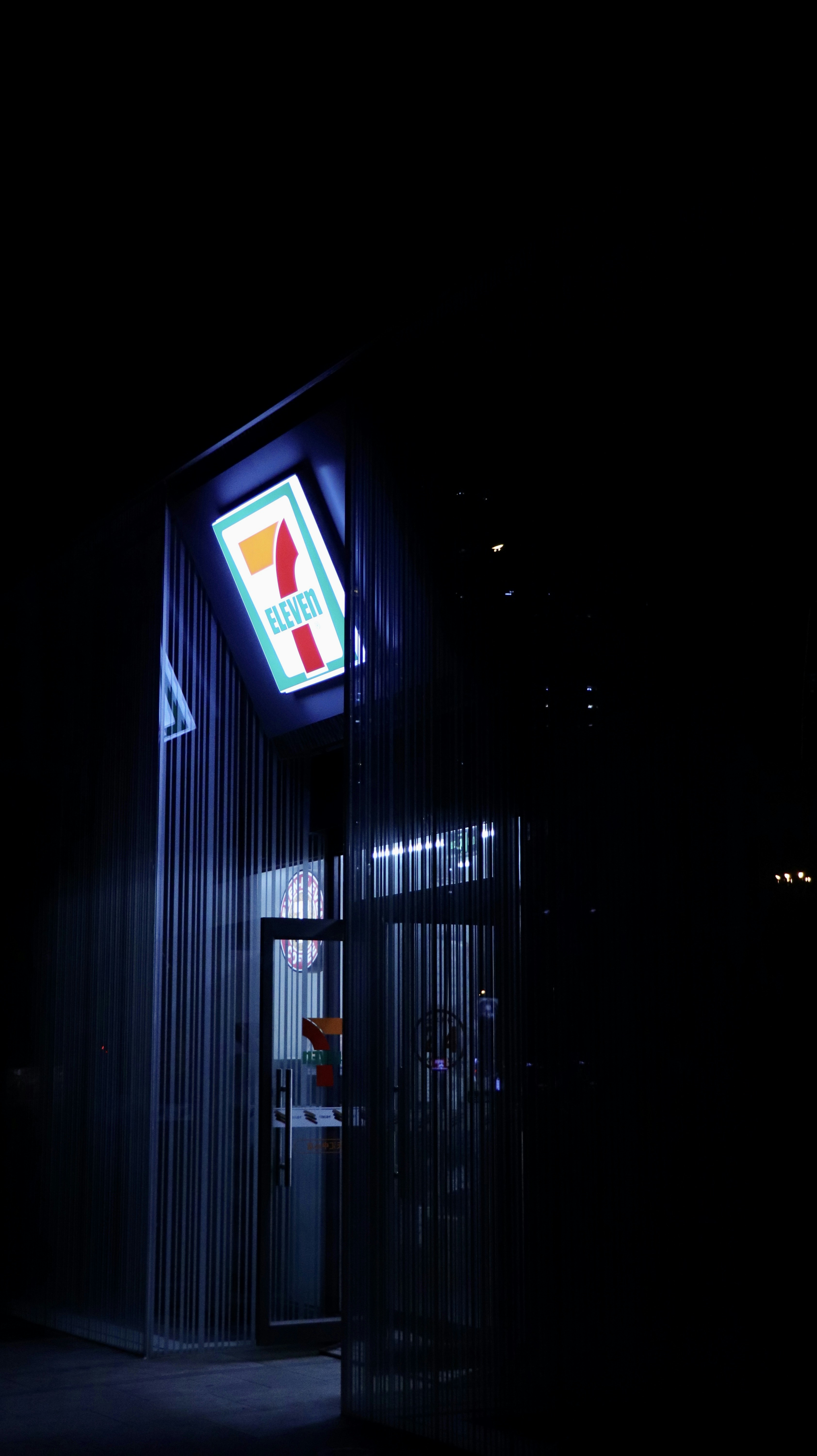 A gas station sign lit up at night photo – Free Logo Image on Unsplash