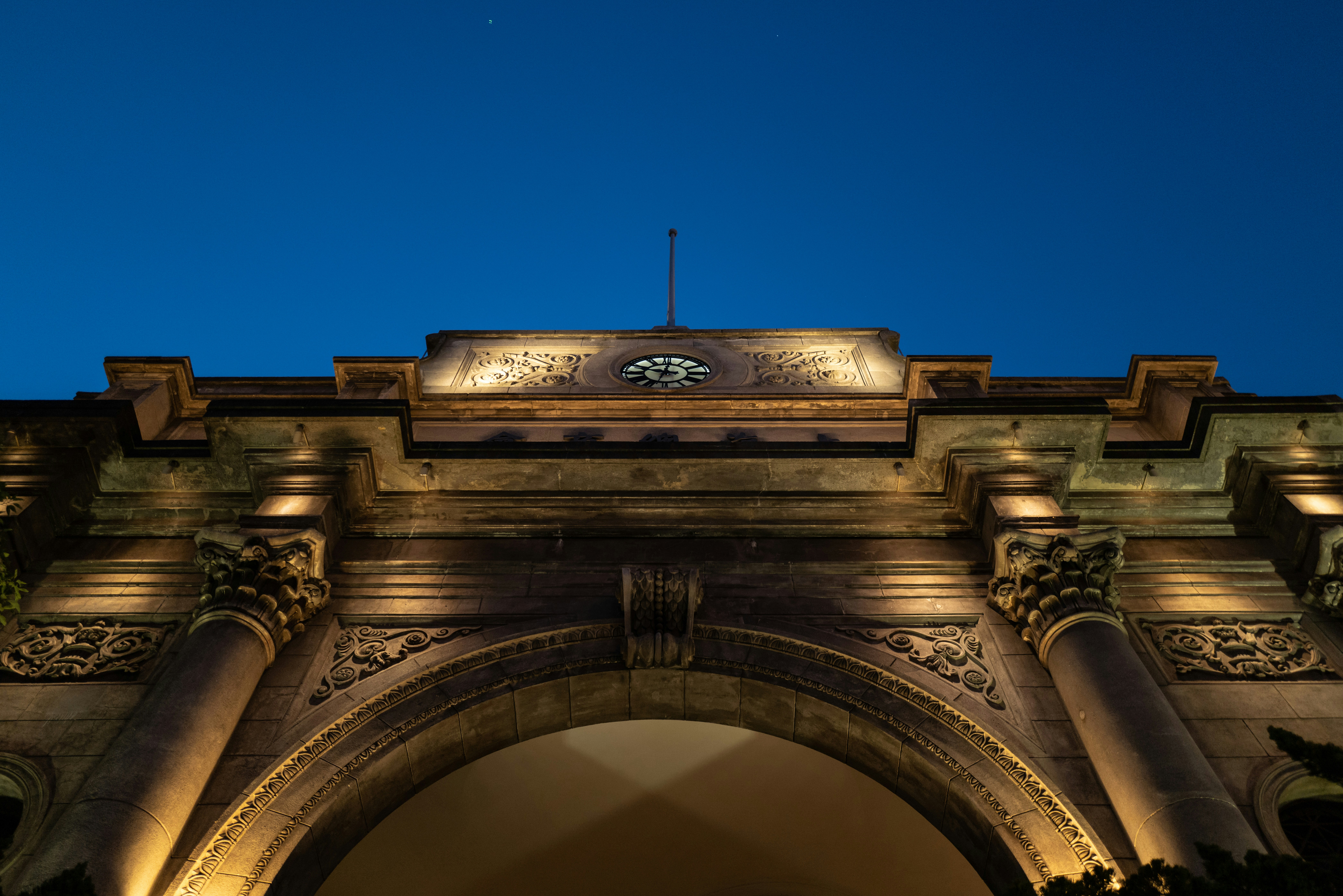 Guardians of the Arch: A Clocked Facade Under Nightfall