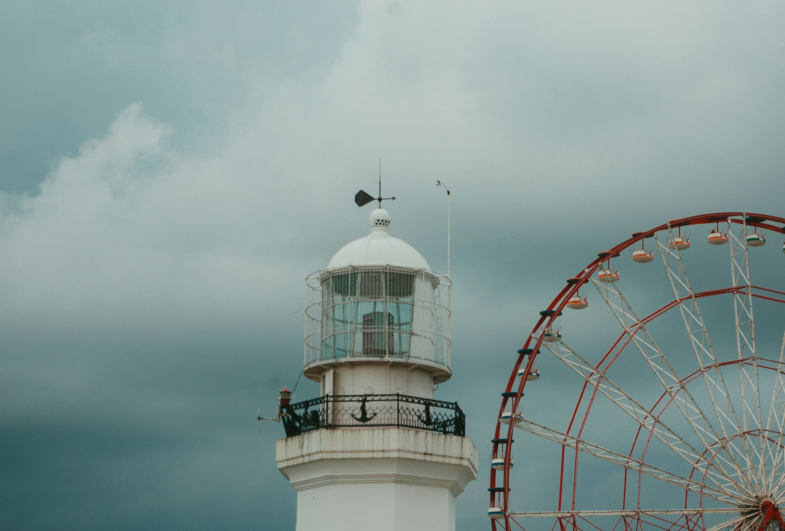 Lighthouse Sentinel beside a Suspended Wheel