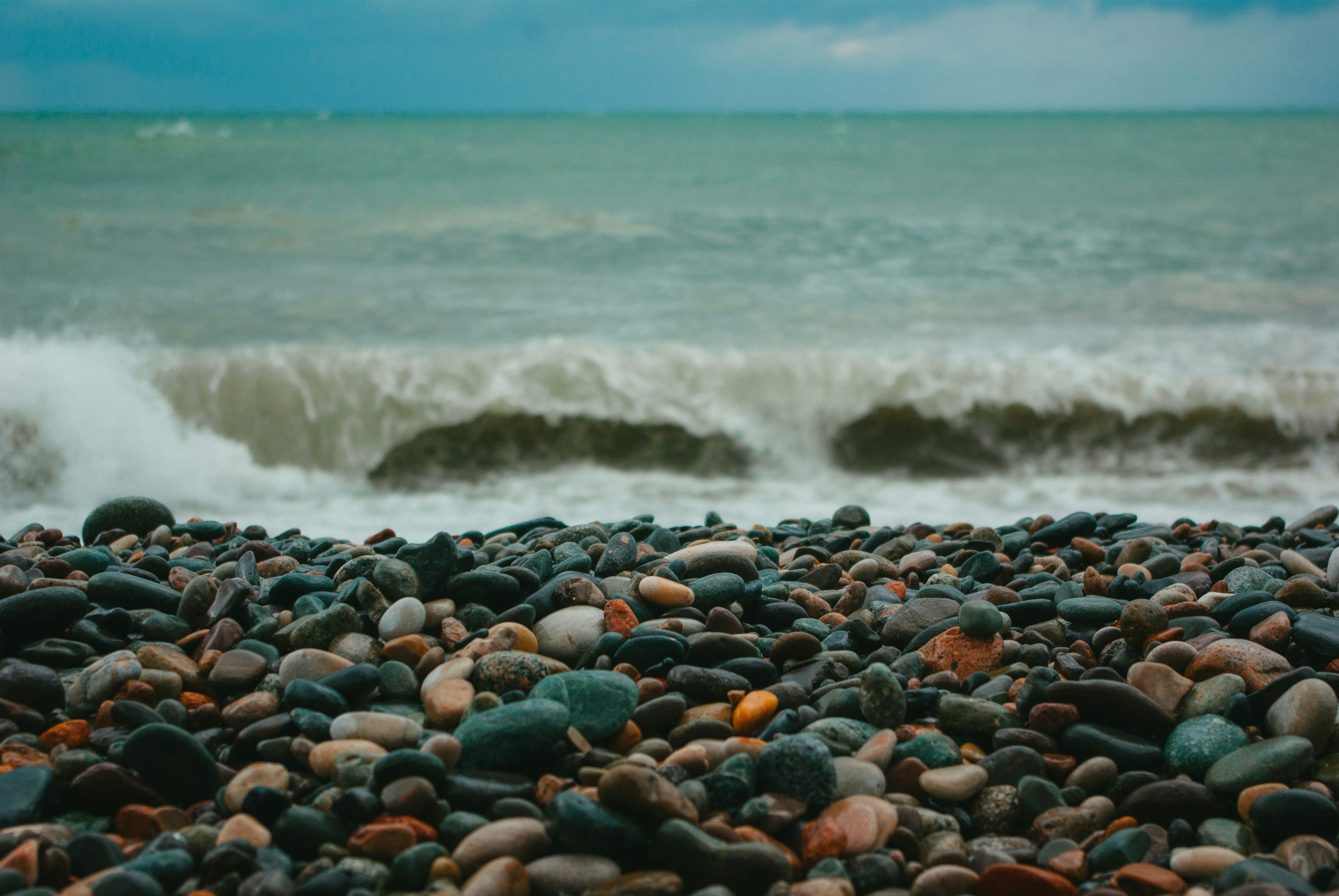 A bunch of rocks on a beach near the ocean photo – Free Sea Image on ...