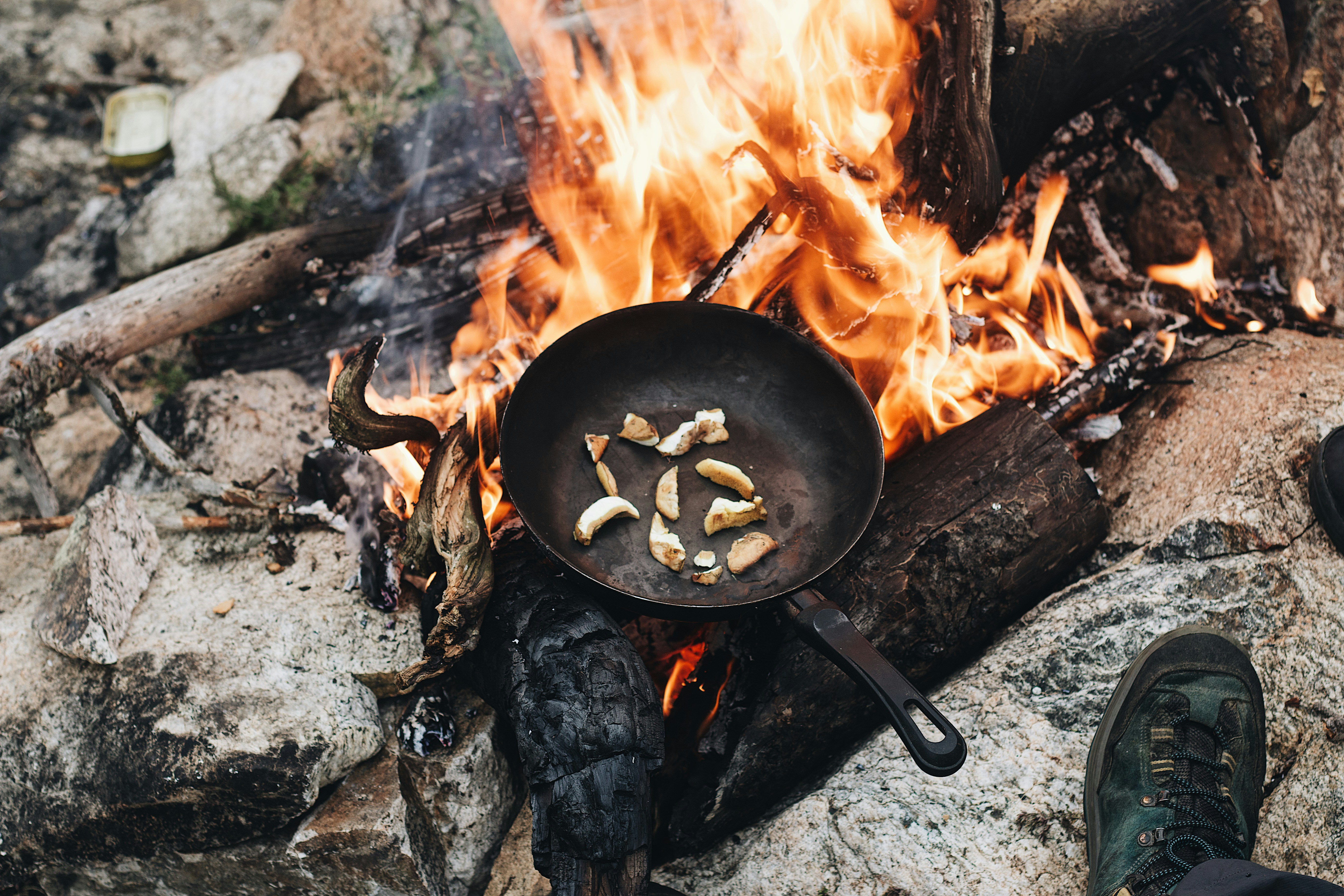 A frying pan sitting on top of a campfire photo – Free Bonfire Image on ...