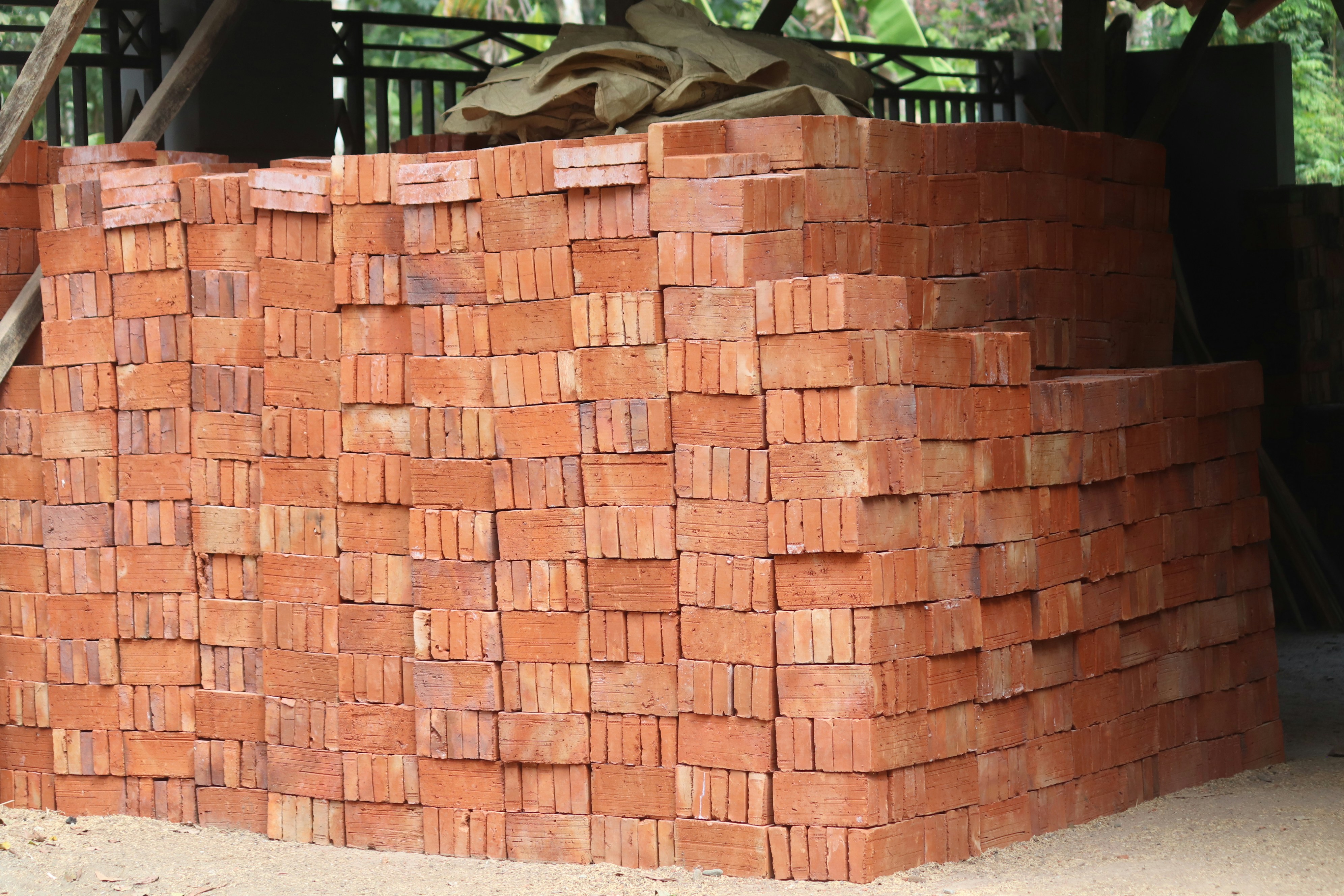 A pile of bricks sitting on top of a sidewalk photo – Free Purwojati ...
