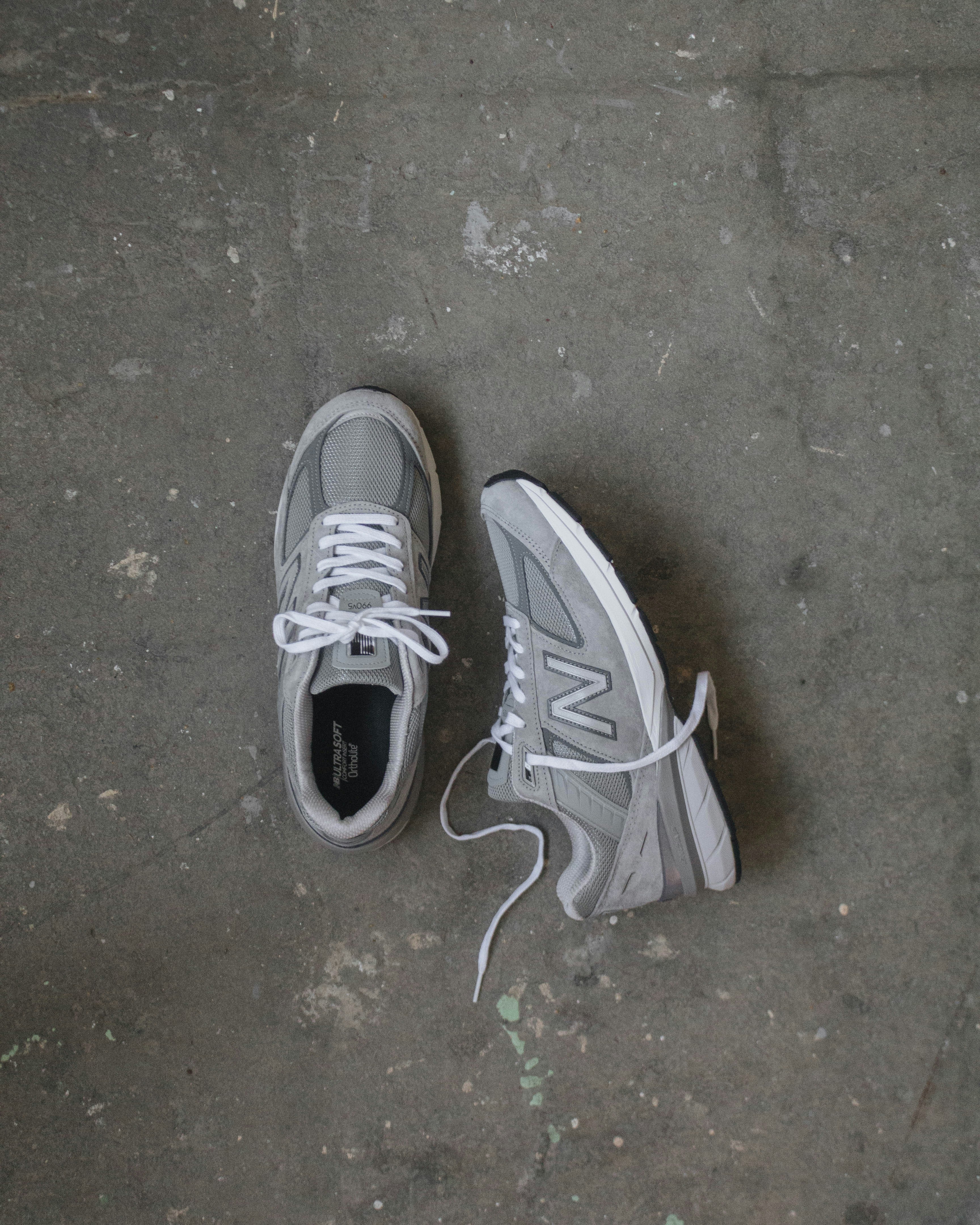 Grounded in Gray: A Quiet Pair of New Balance Sneakers on Weathered Concrete
