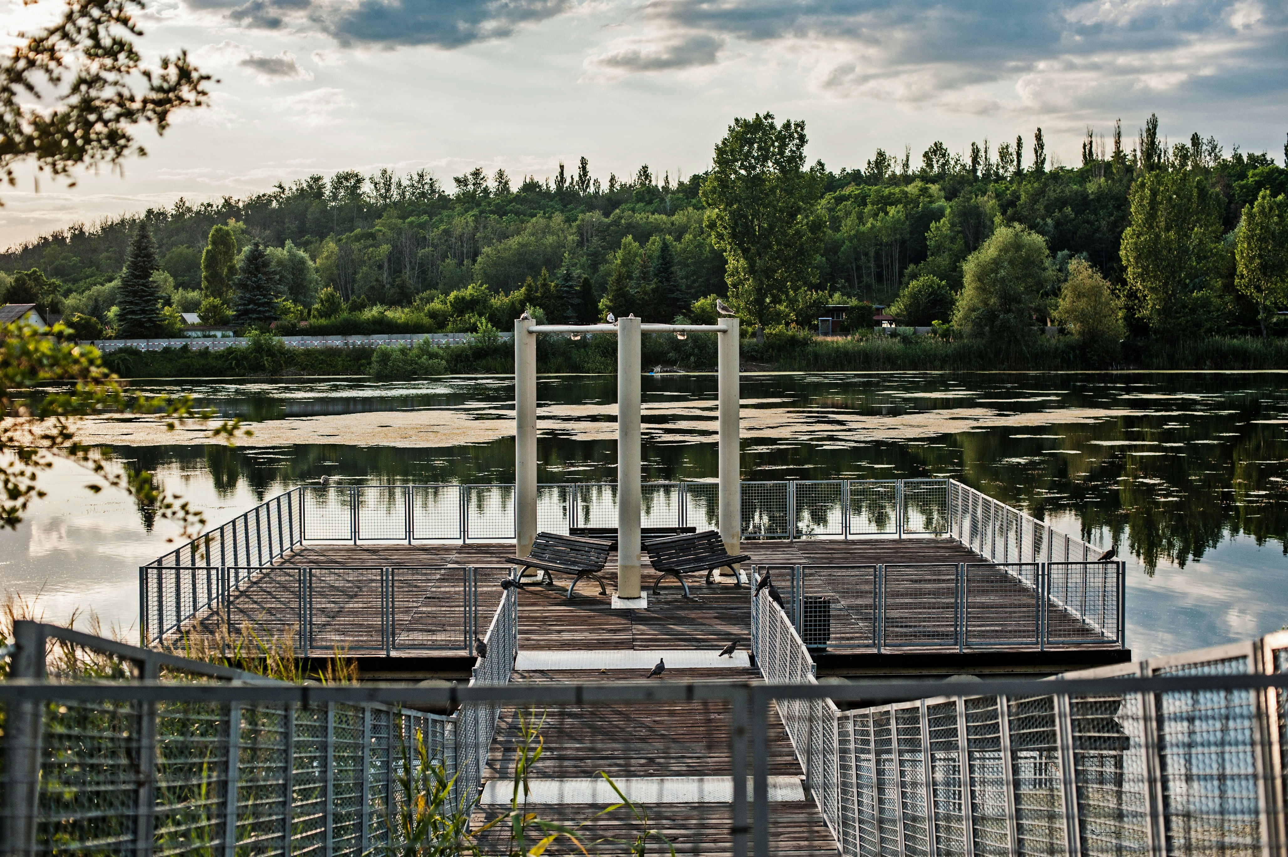 Twin Pylons at a Quiet Dock Reaching Into a Glassy Lake