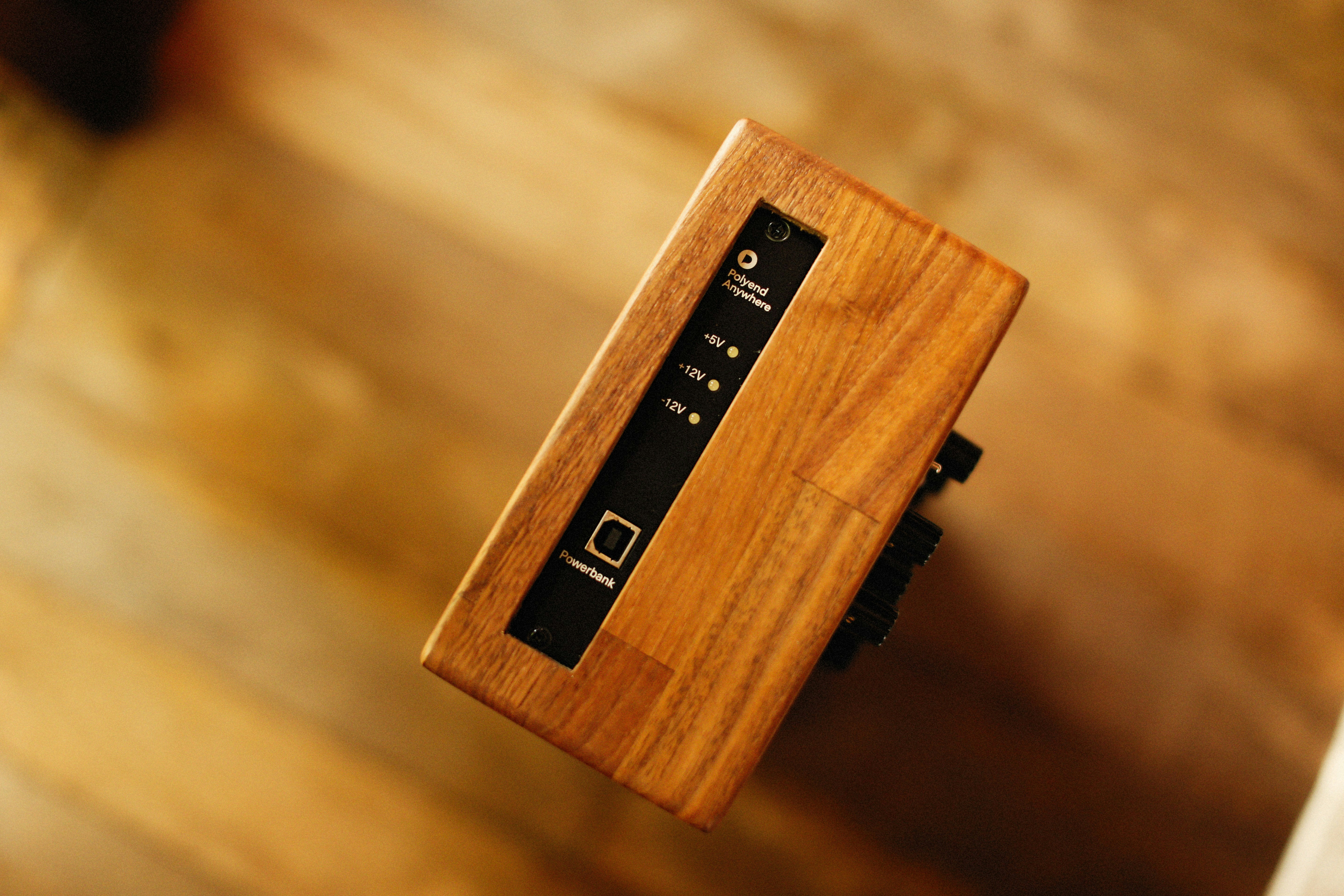 Honeyed Walnut Box Camera Balancing on a Warm Studio Floor