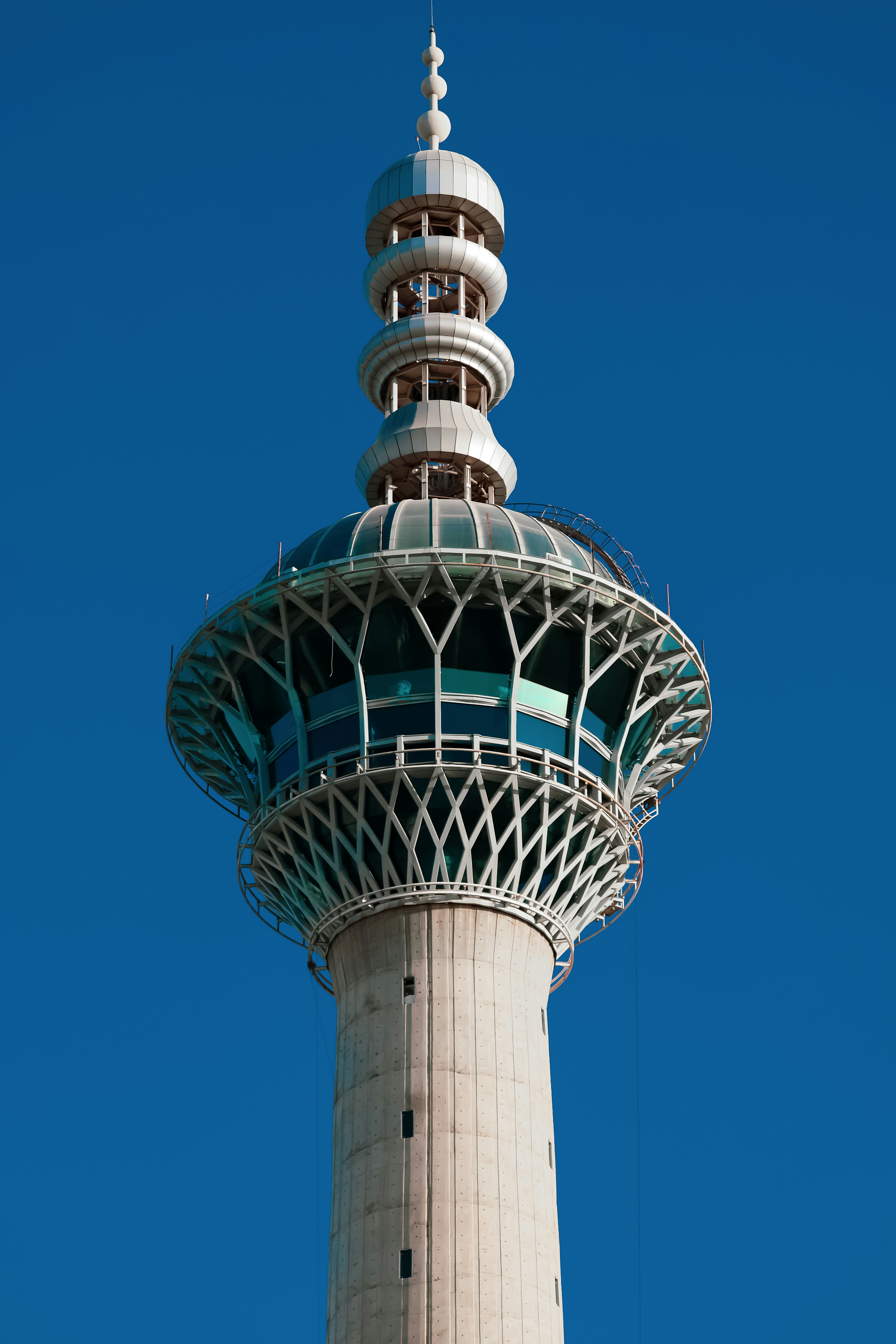 a tall white tower with a blue sky in the background