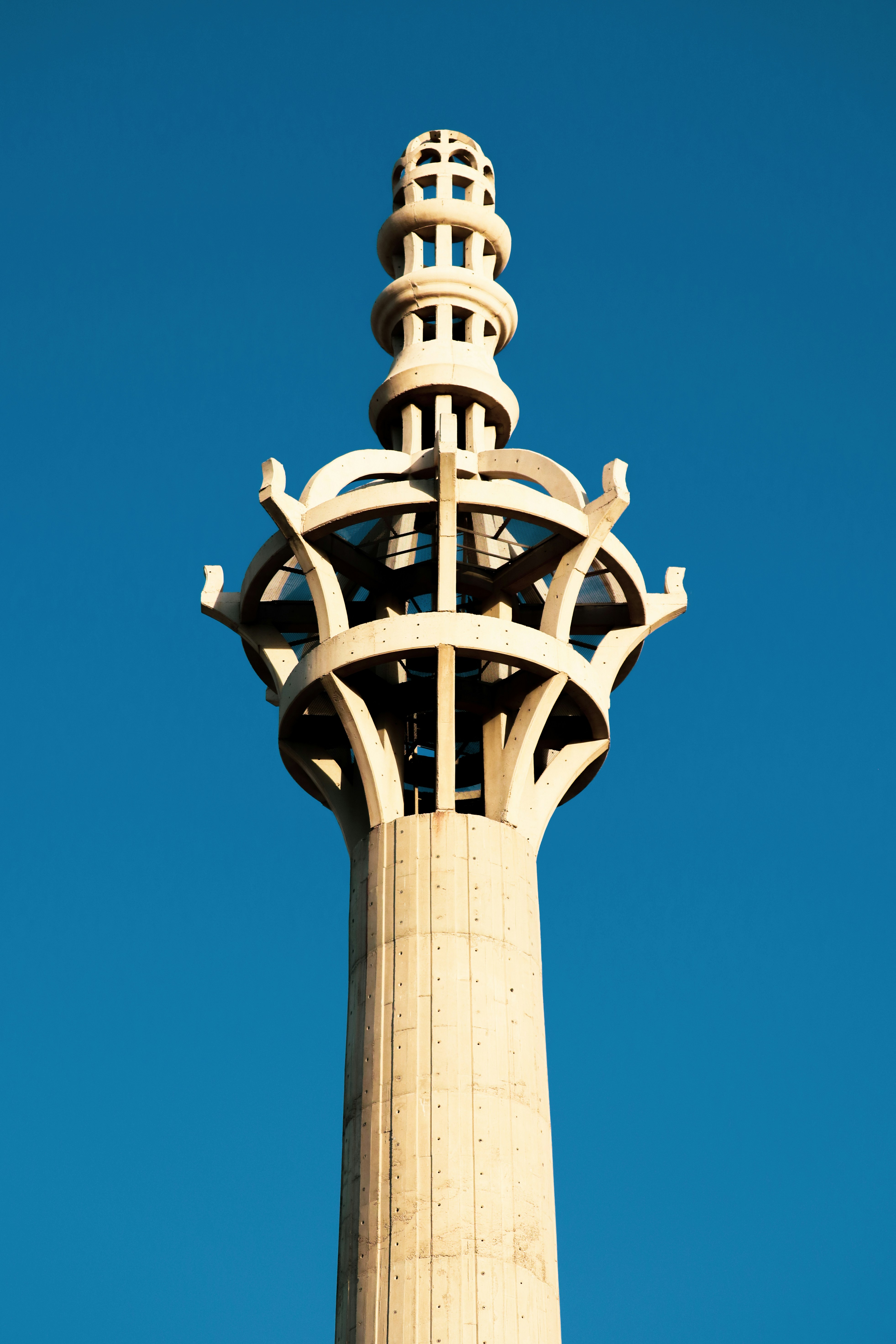 Crown of Geometry: The Arch-Cluster Tower Against a Clear Sky
