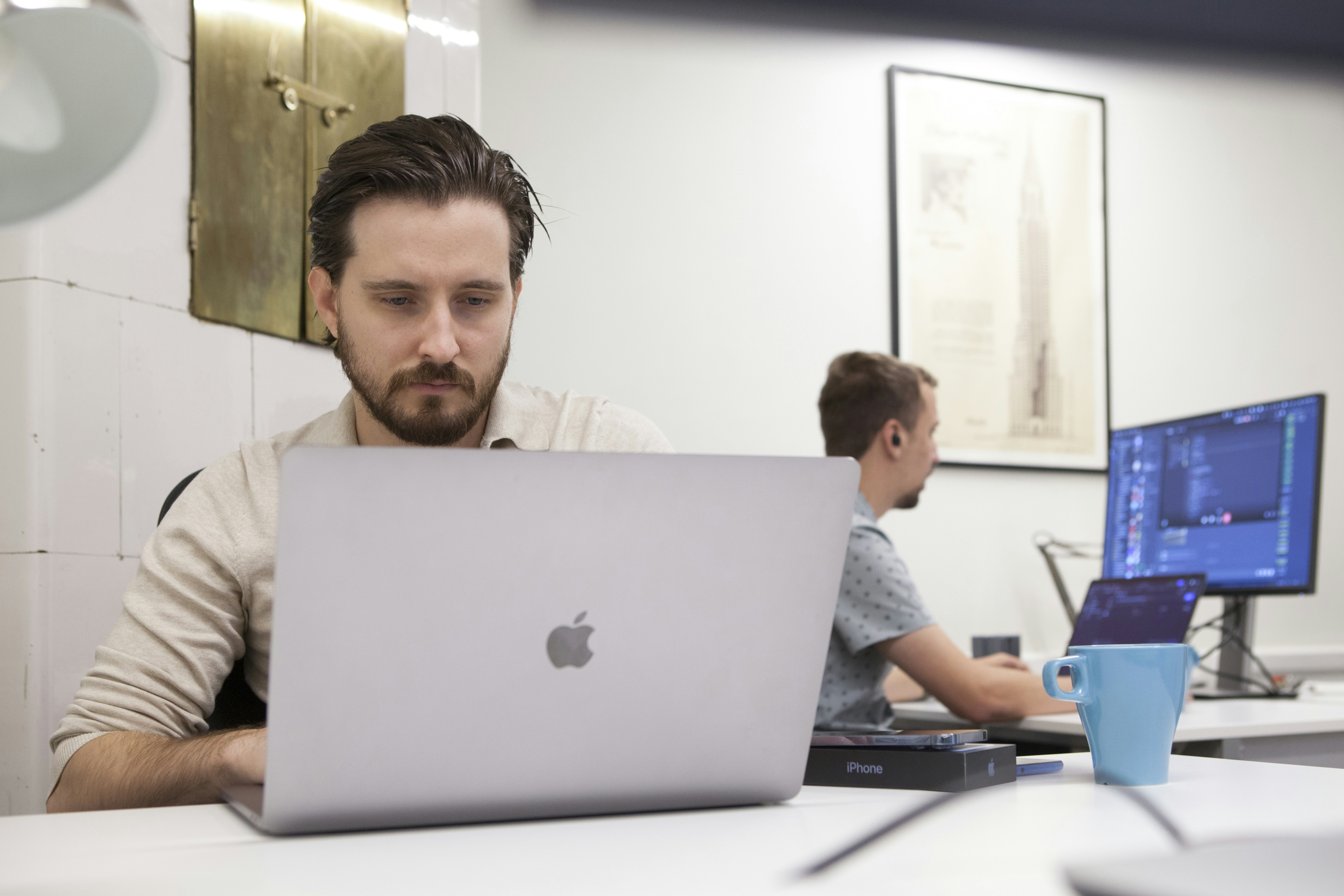 A man sitting in front of a laptop computer photo – Free Office Image ...