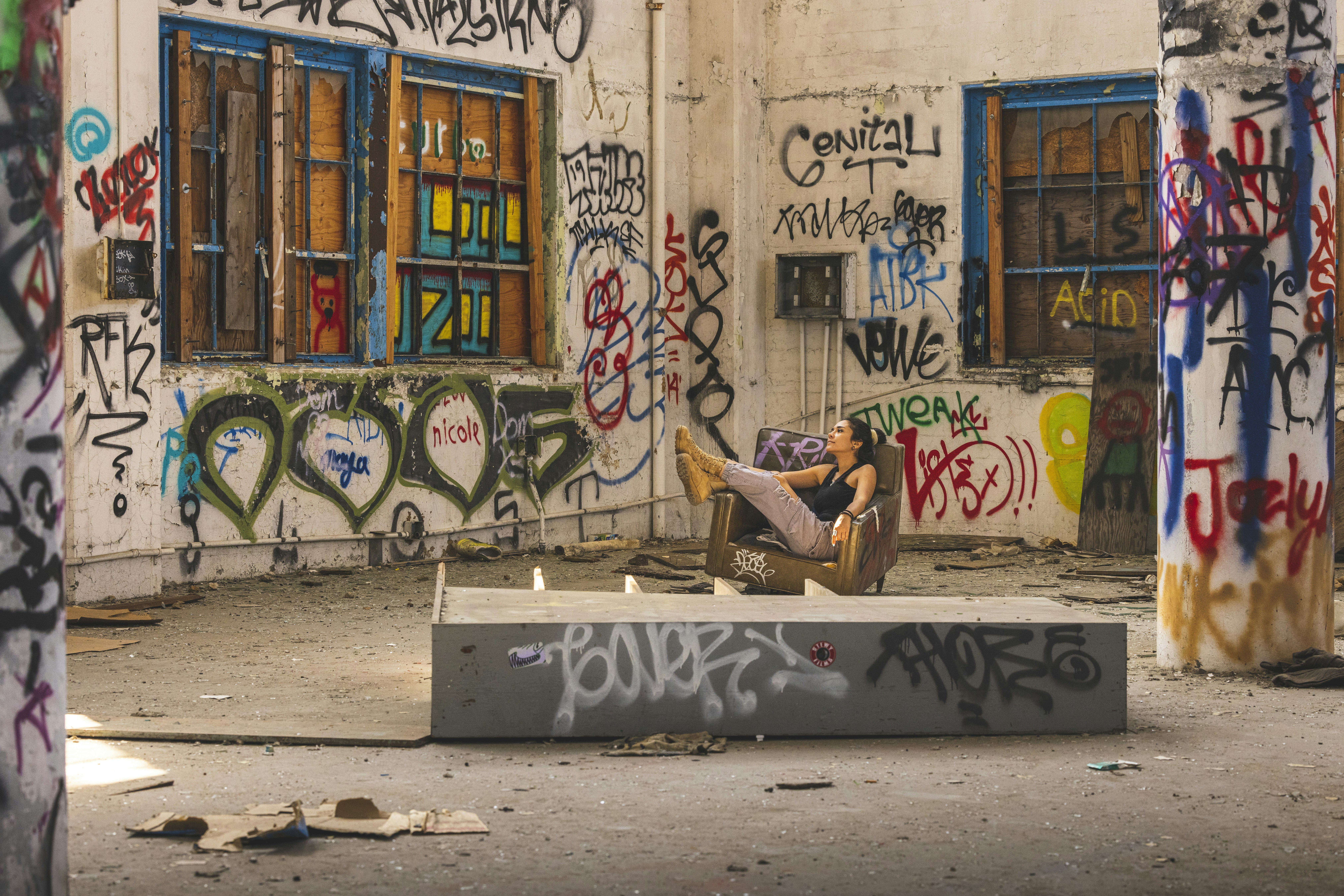 Graffiti Studio: A Seated Figure amidst Urban Color and Concrete