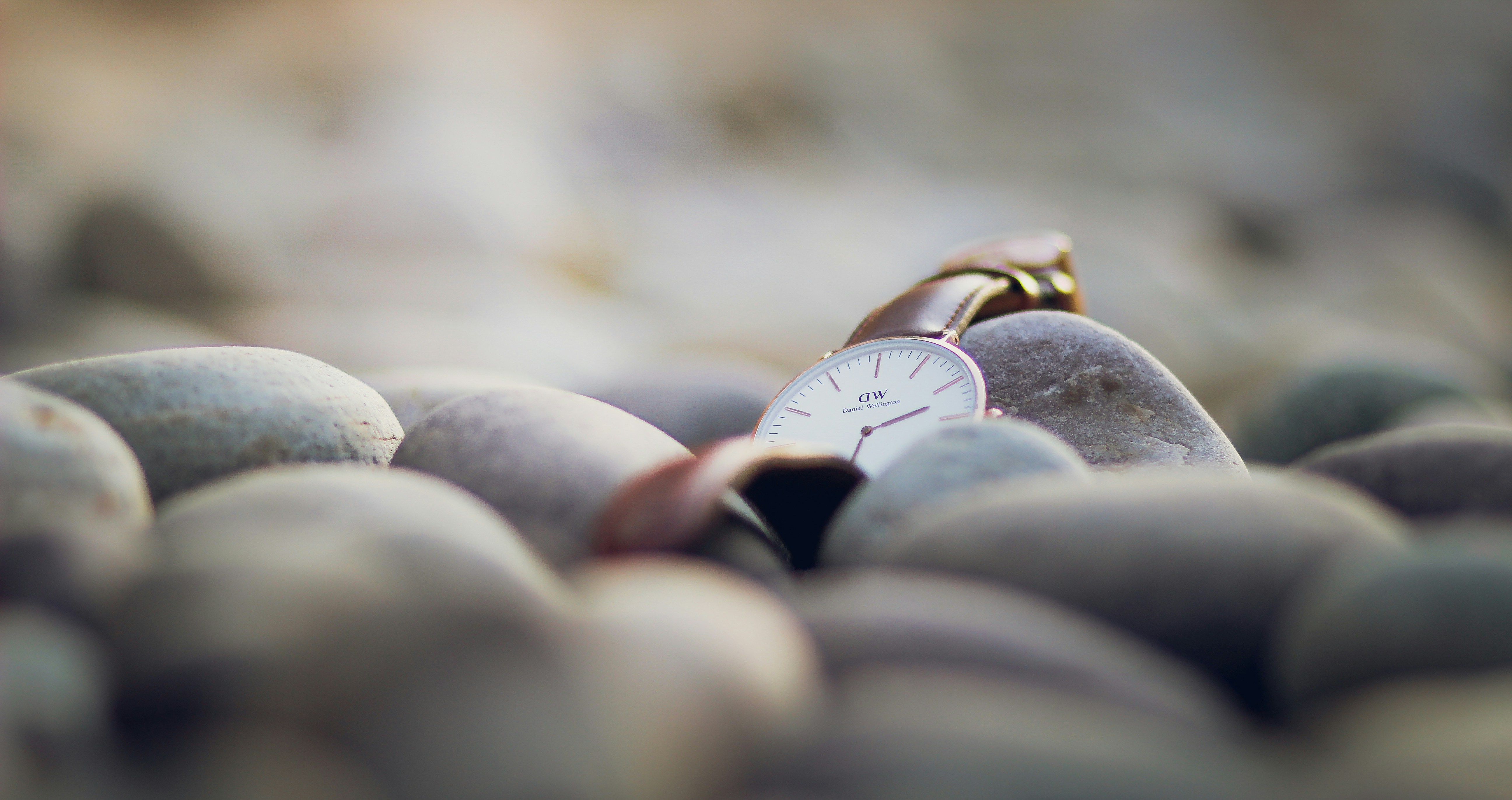 A watch sitting on top of a pile of rocks photo – Free Manipal ...