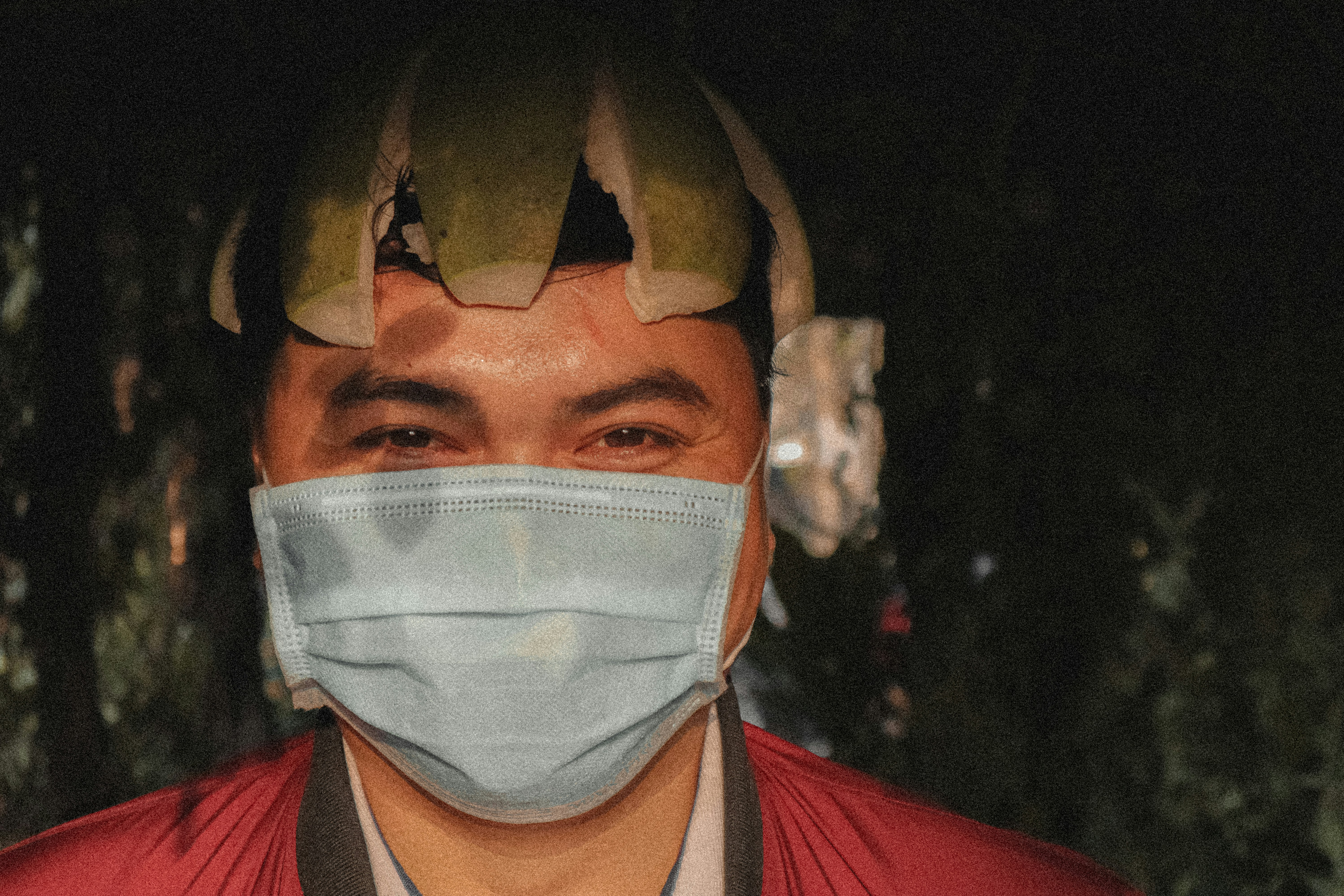 Masked Portrait Beneath a Shadowed Canopy