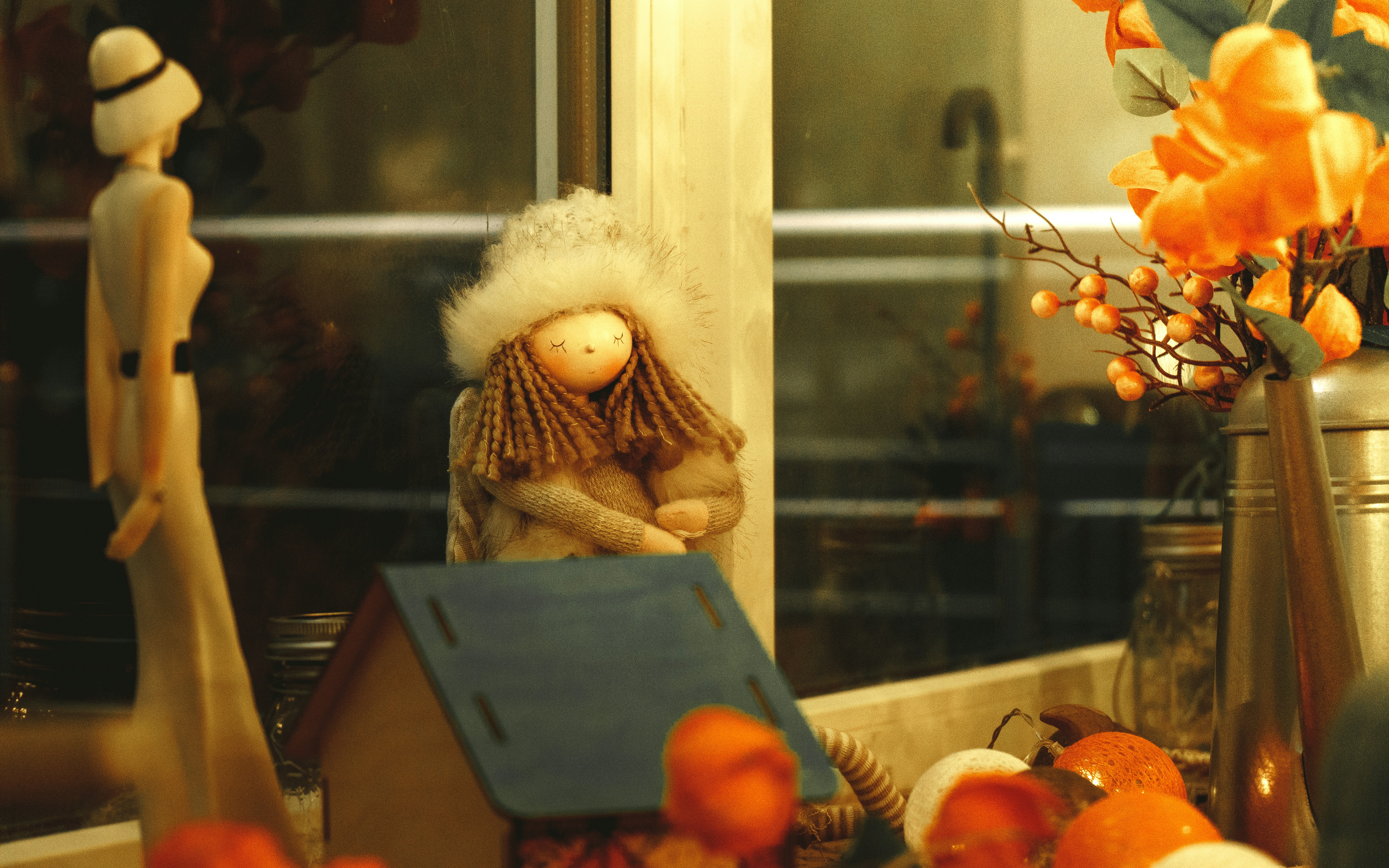 Whimsical Display: A Knit Figure Amid Autumnal Accents