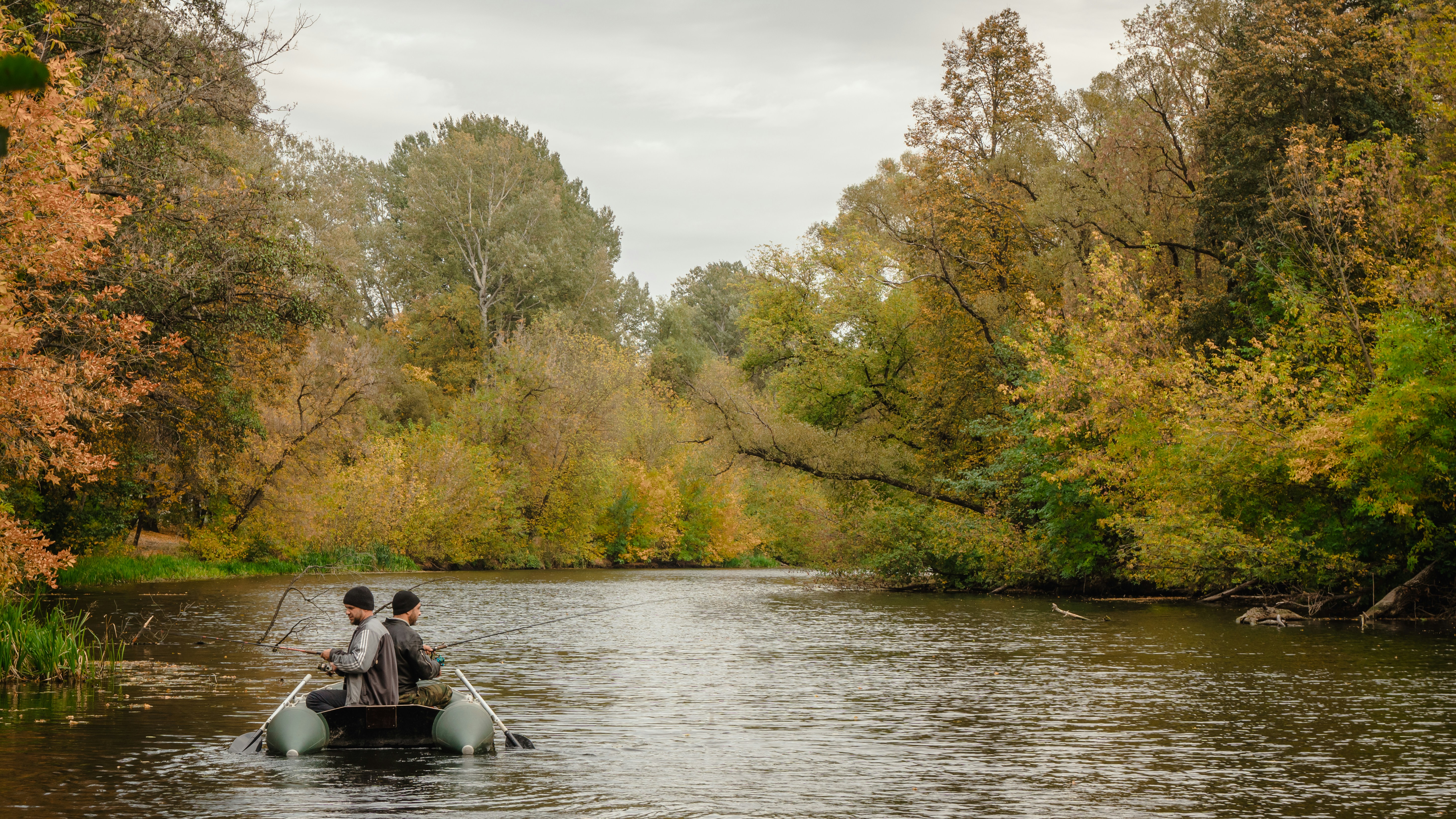 A couple of people riding in a boat down a river photo – Free Human ...