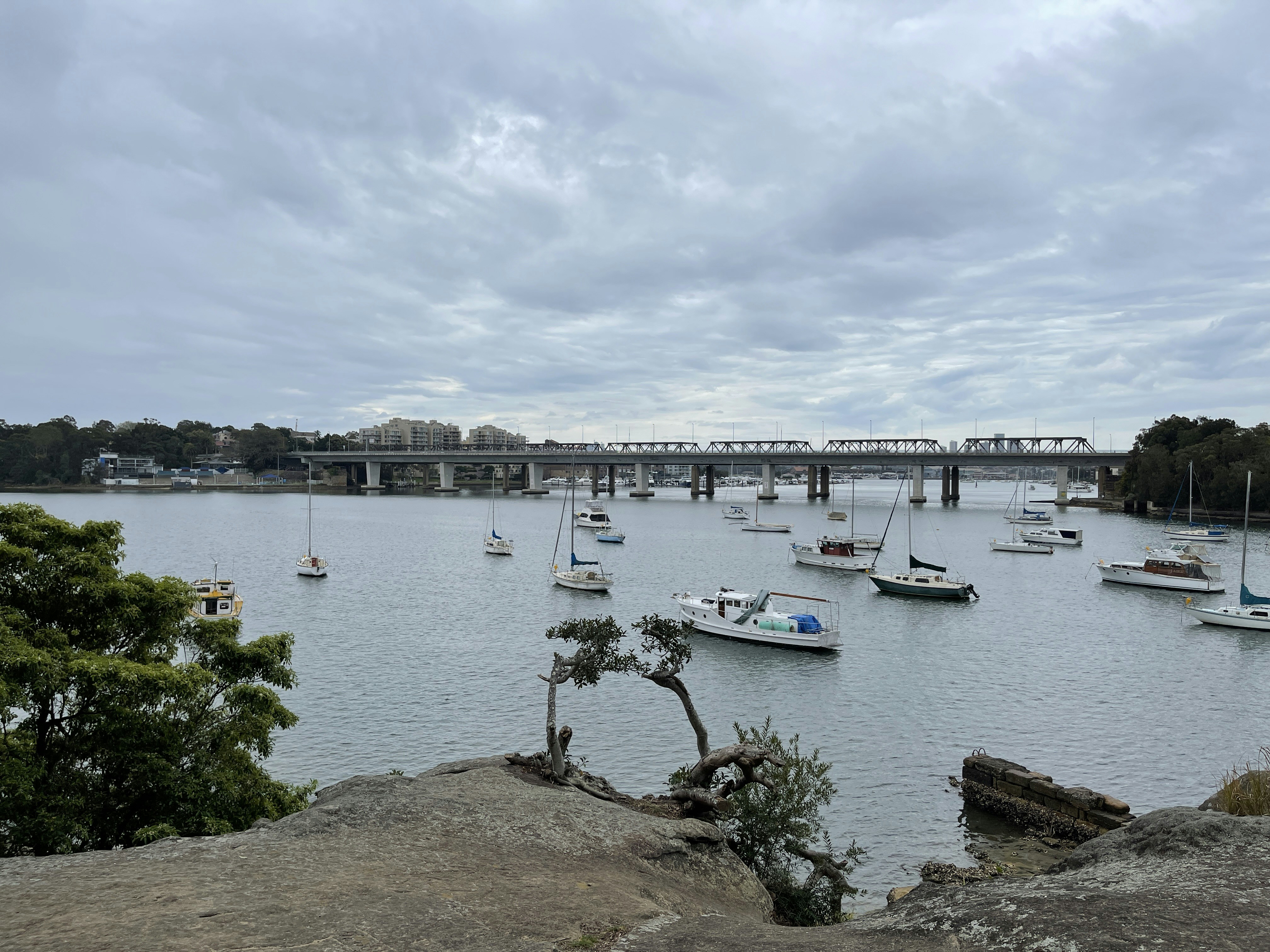 Harbor Bridge in Soft Light: Boats Rest Beneath a Cloudy Sky