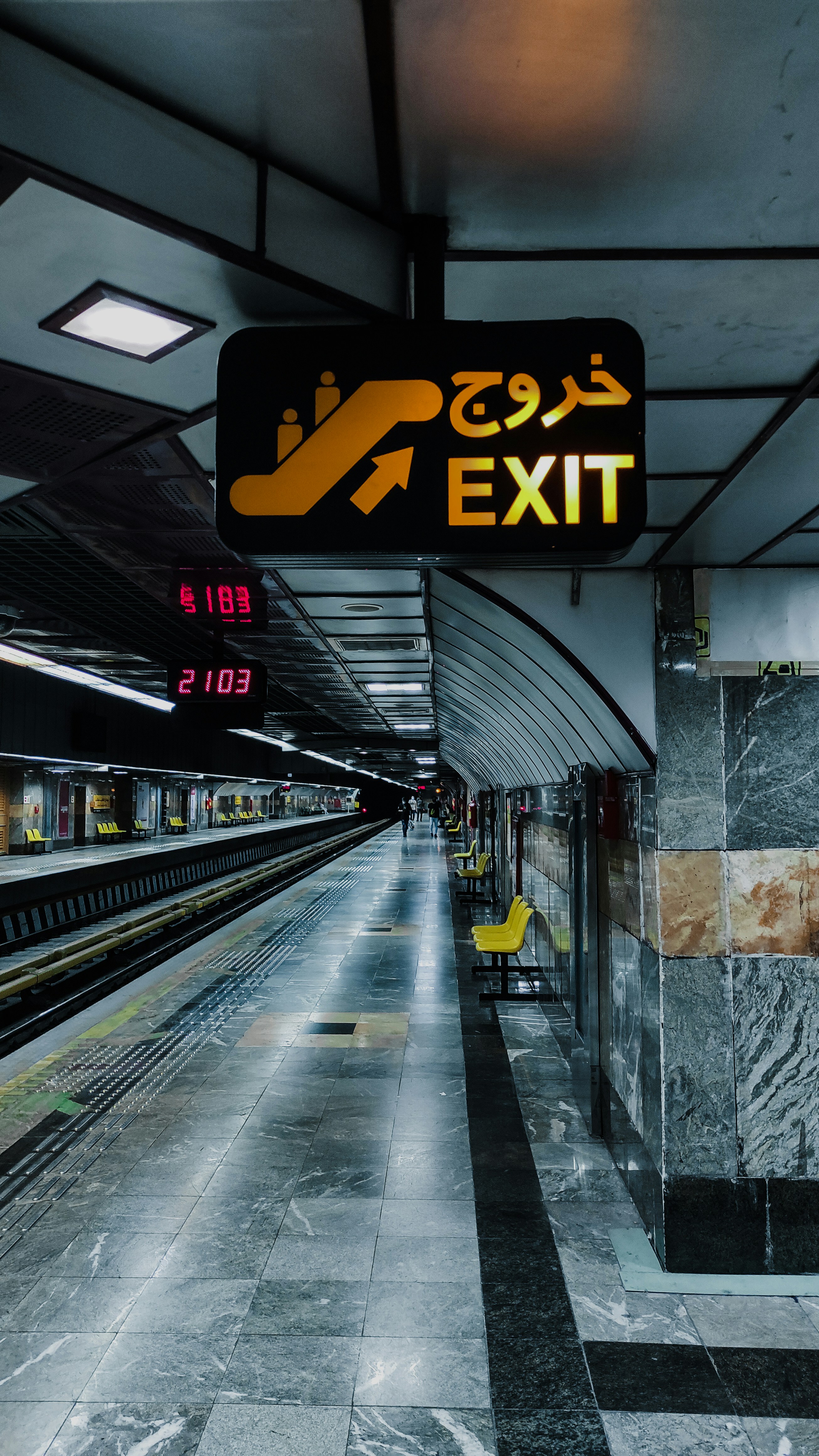 A train station with a sign that says exit photo – Free Dark Image on ...