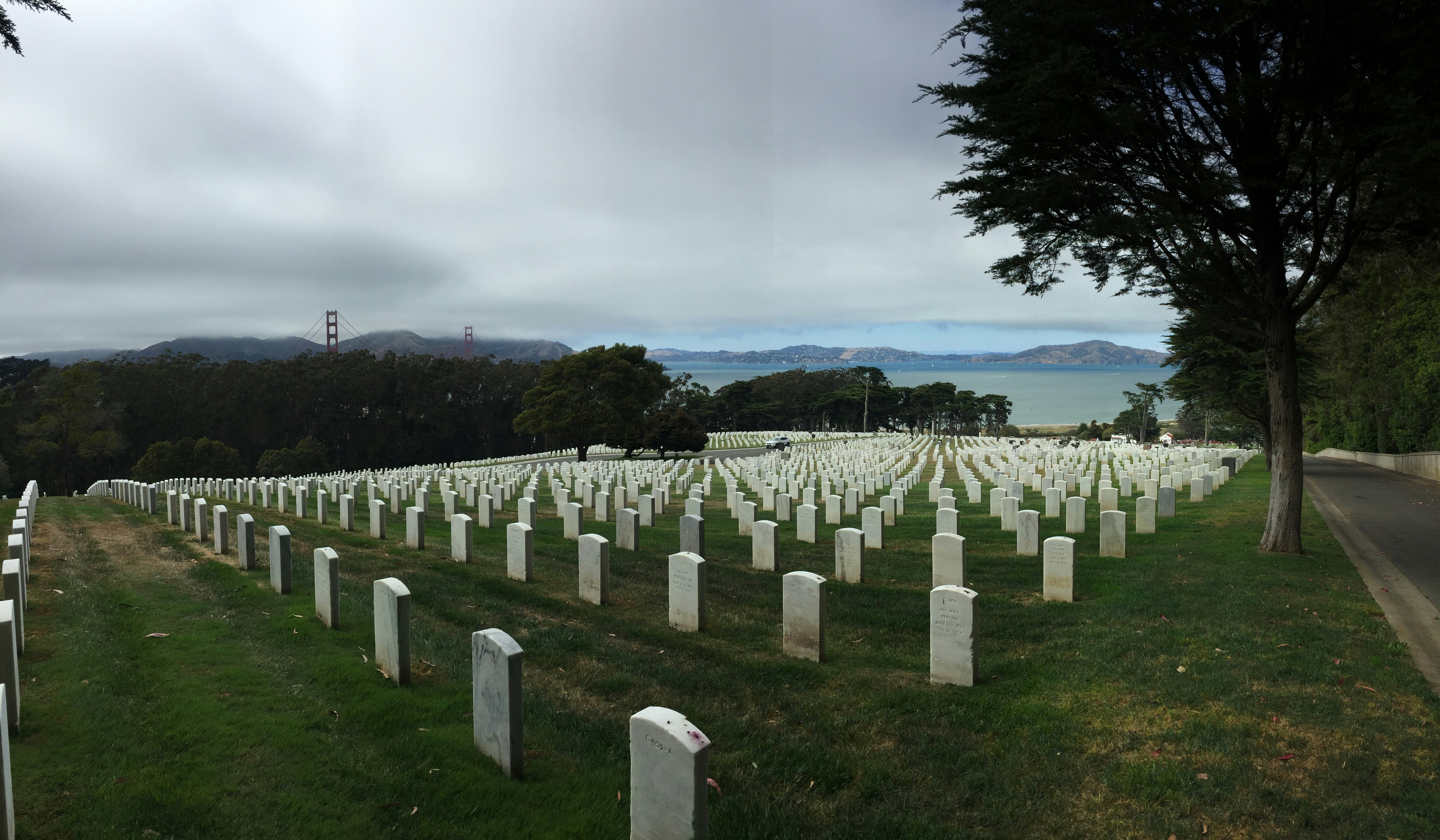 A large cemetery with many headstones in the grass photo – Free Tomb ...