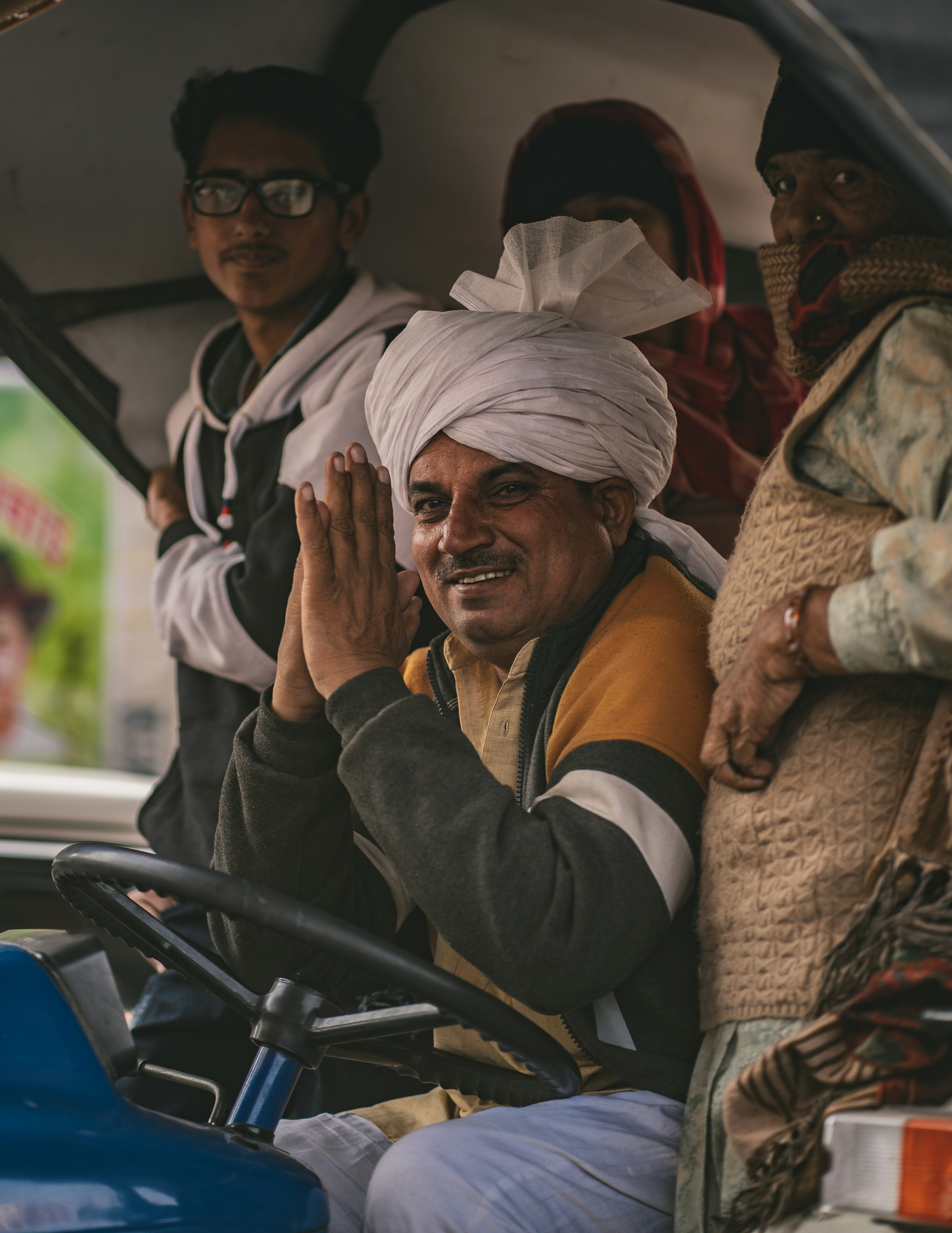 Hands in Welcome: A Three-Person Greeting from a Tuk-Tuk Driver