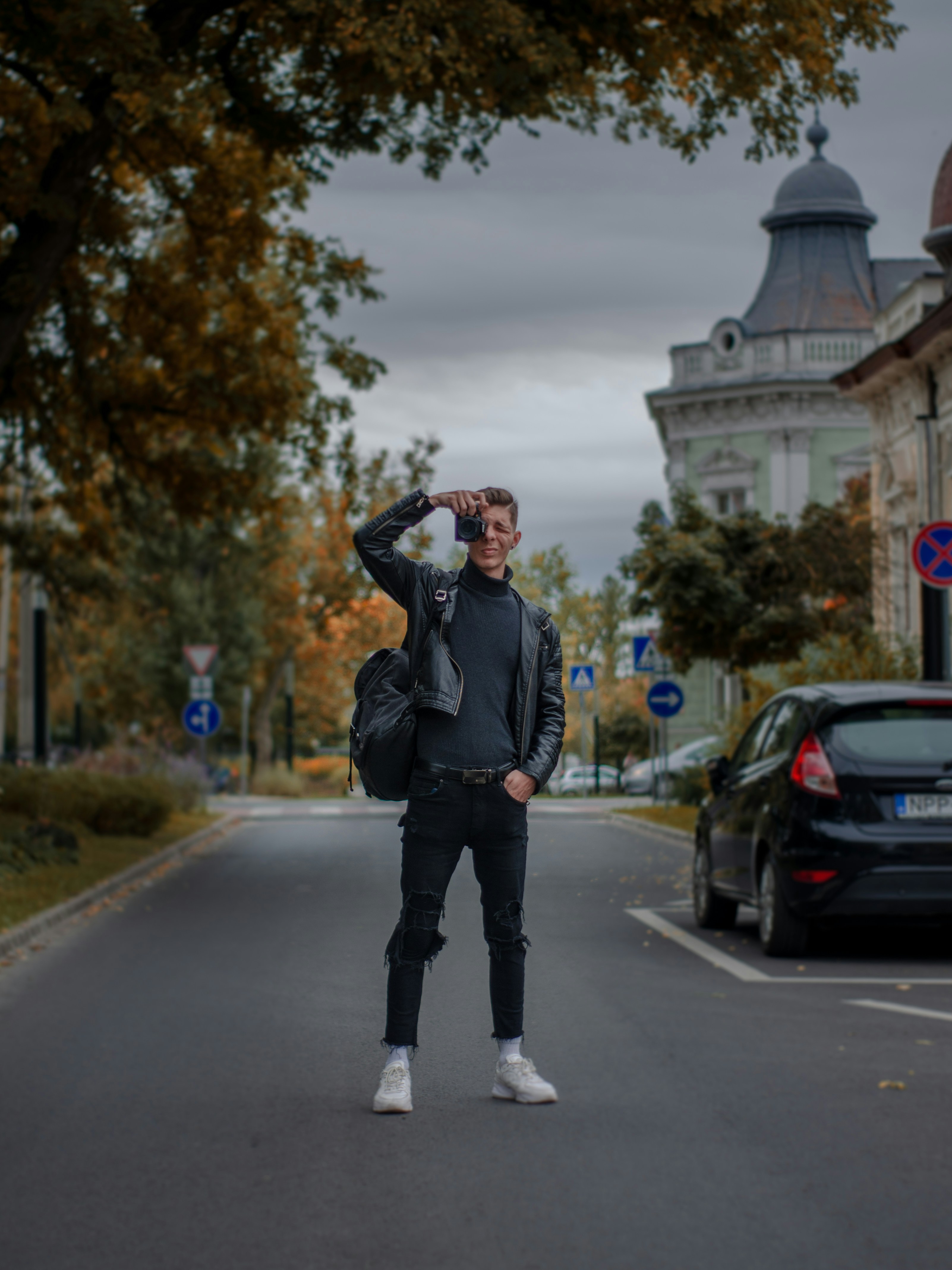 Autumn Street Portrait: A Confident Wanderer Halts the Quiet City Lane