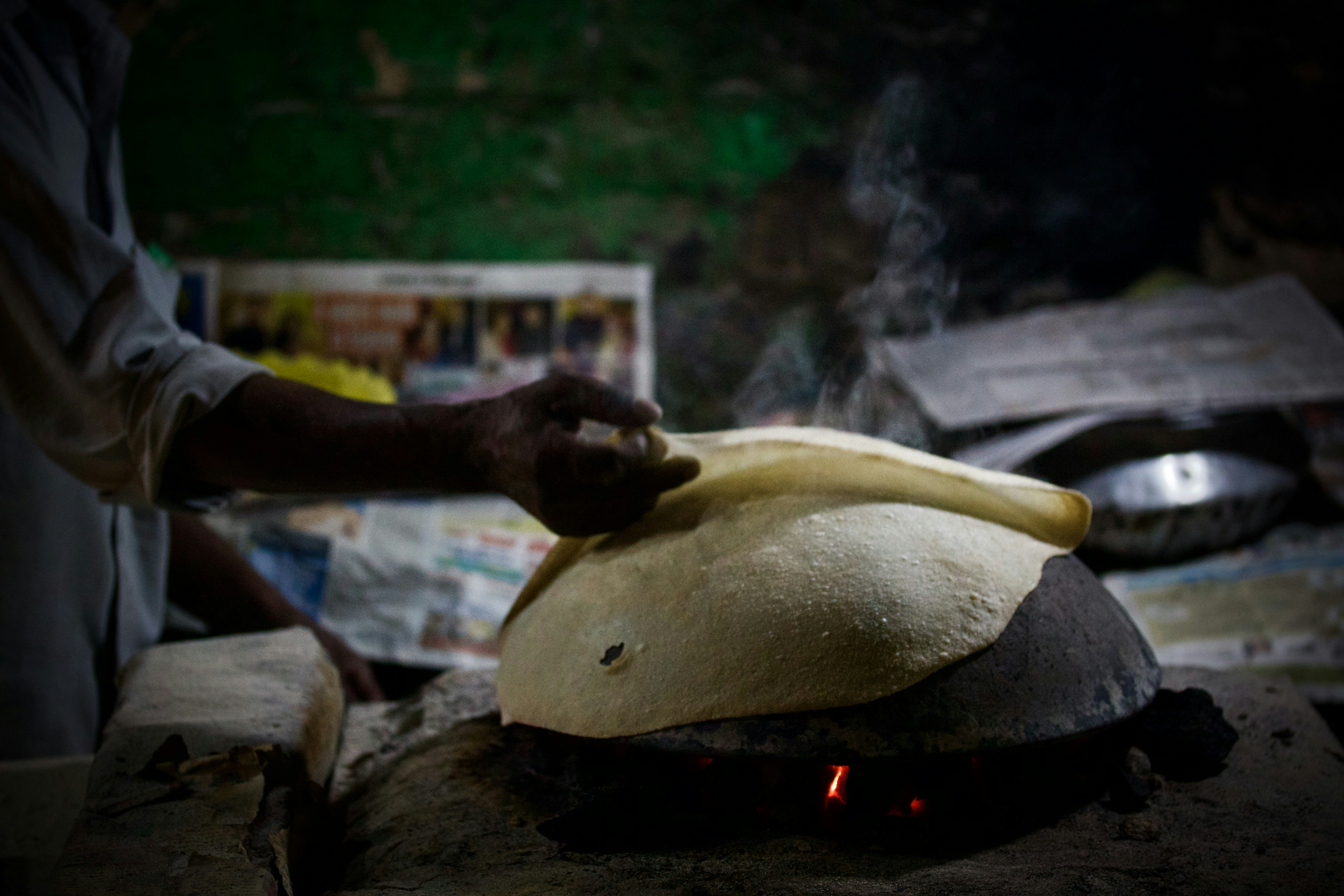 a man is making a large piece of bread
