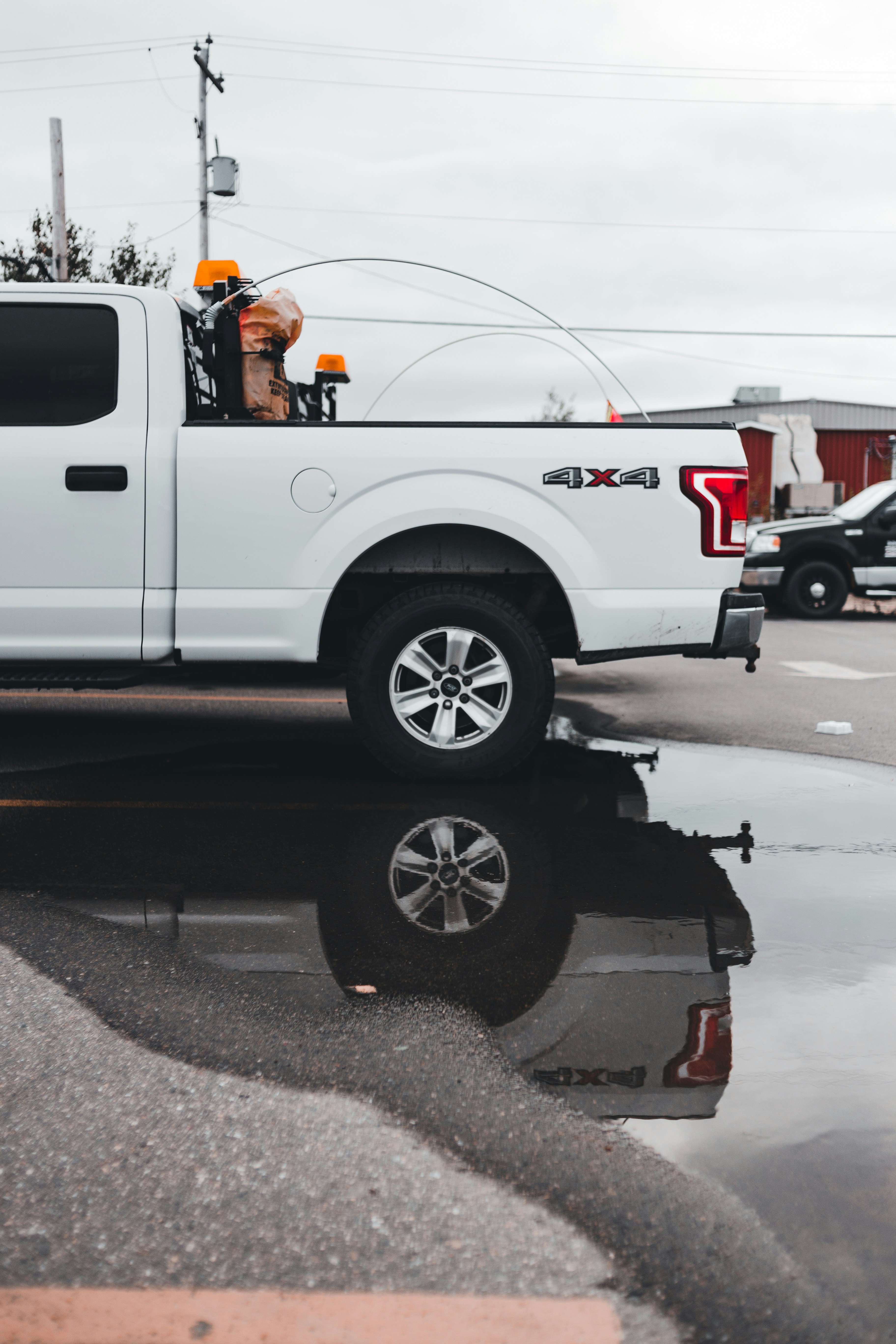 Reflection of a Work Truck: still life in a parking lot puddle