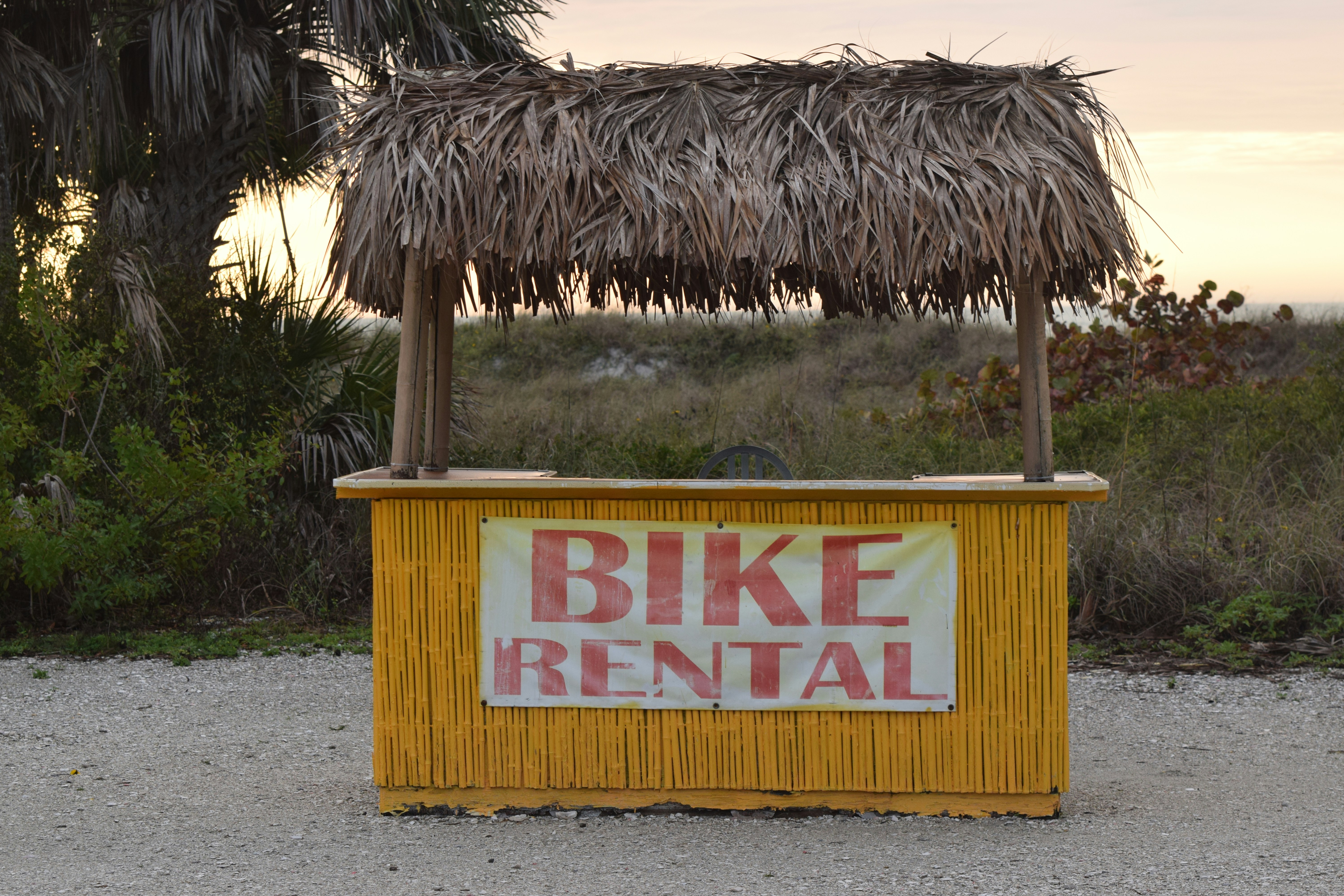 A tiki stand with a sign that says bike rental photo – Free Land Image ...