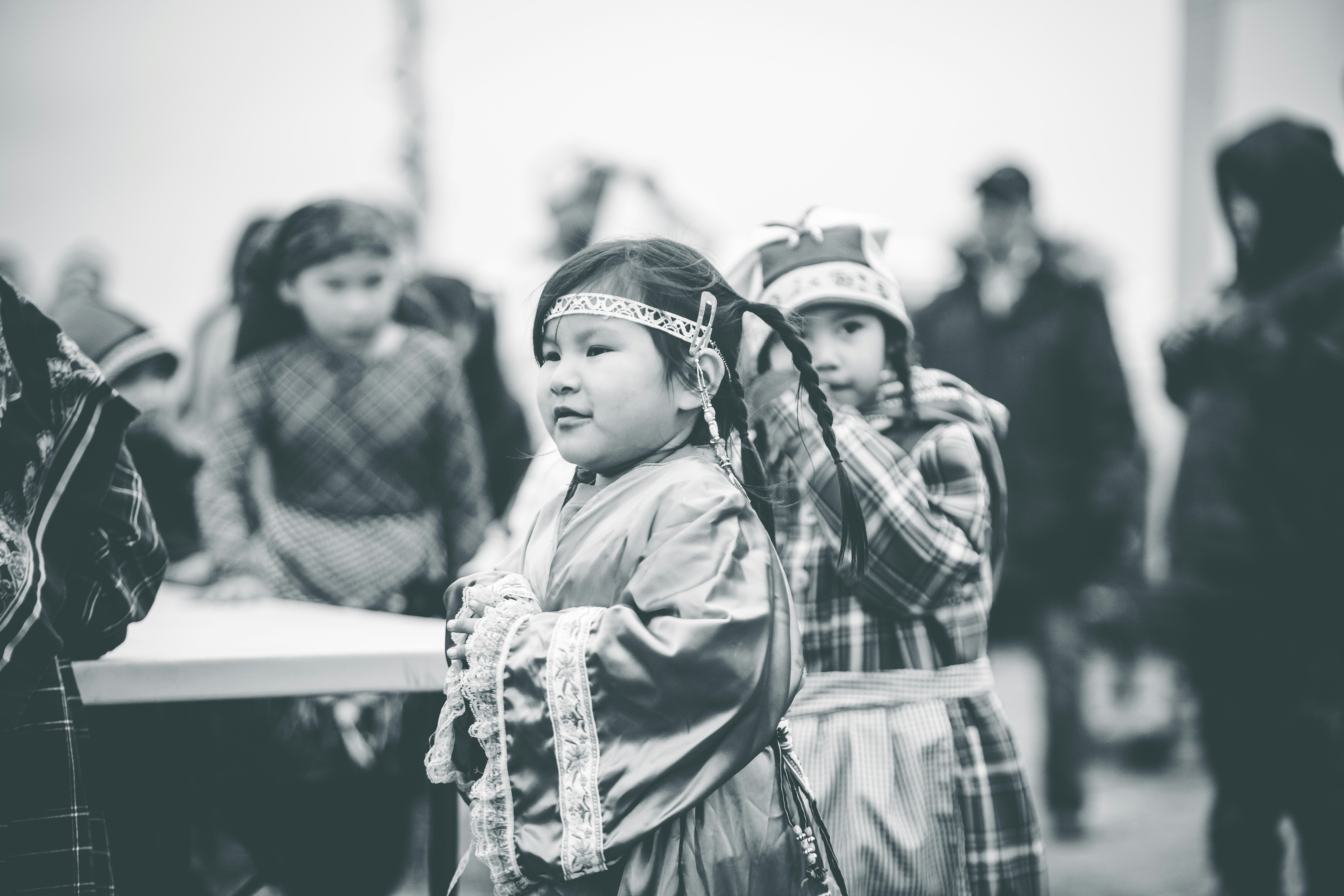 Young dancer with ceremonial headband leads a quiet procession
