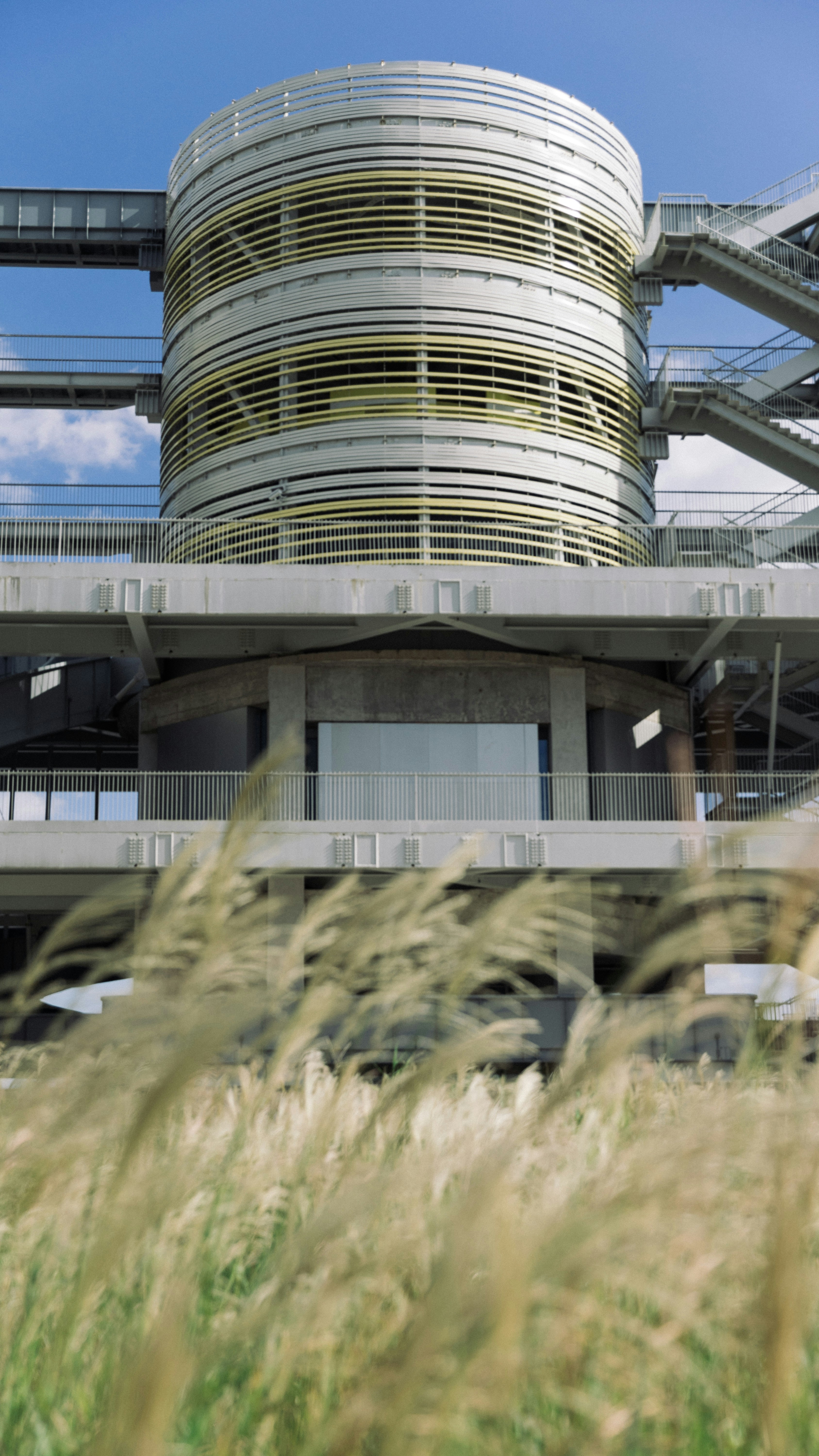 Cylindrical Spire Above the Skywalk: Metal Rings and Sky Bridges