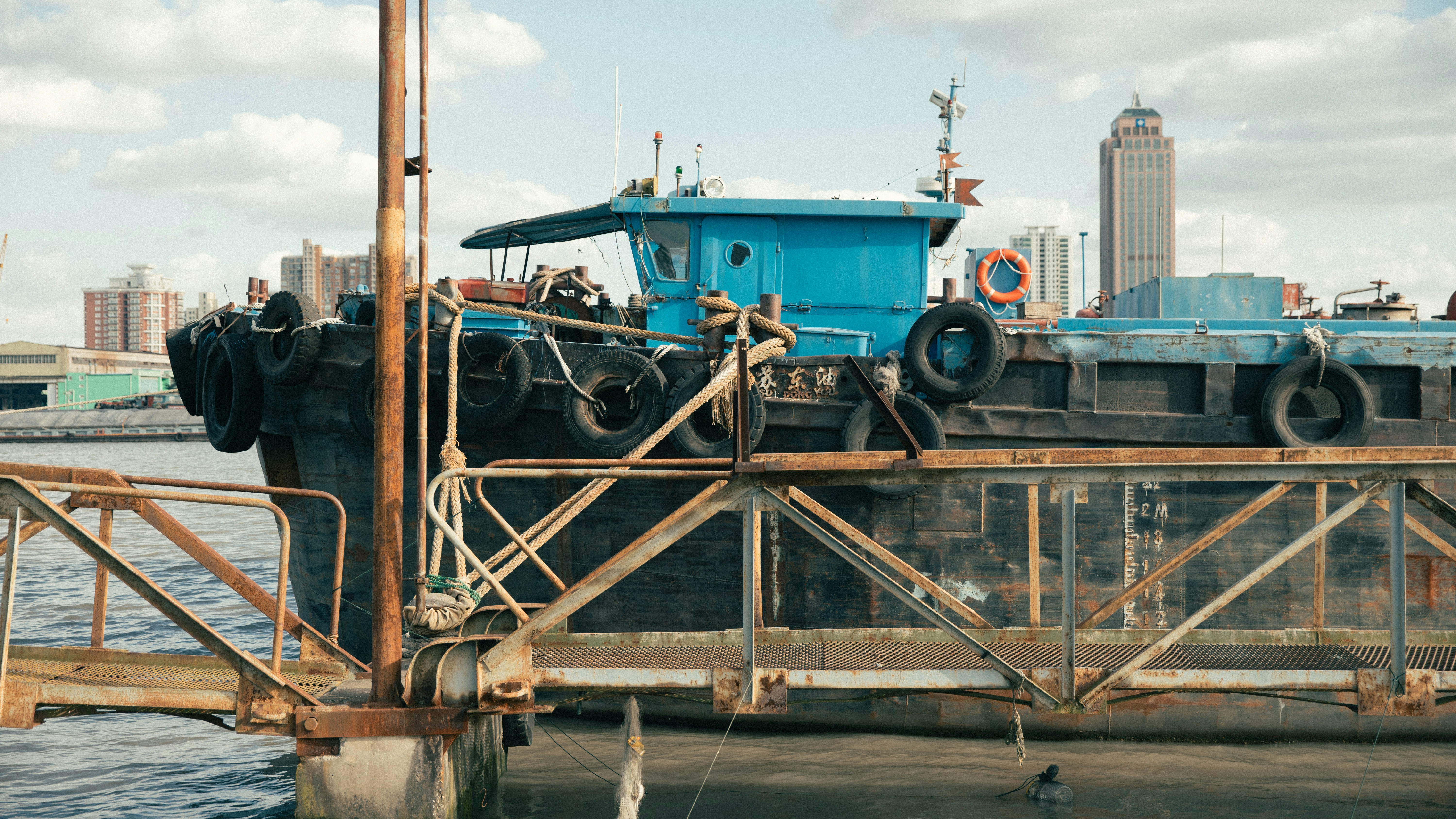 a large blue boat sitting on top of a pier
