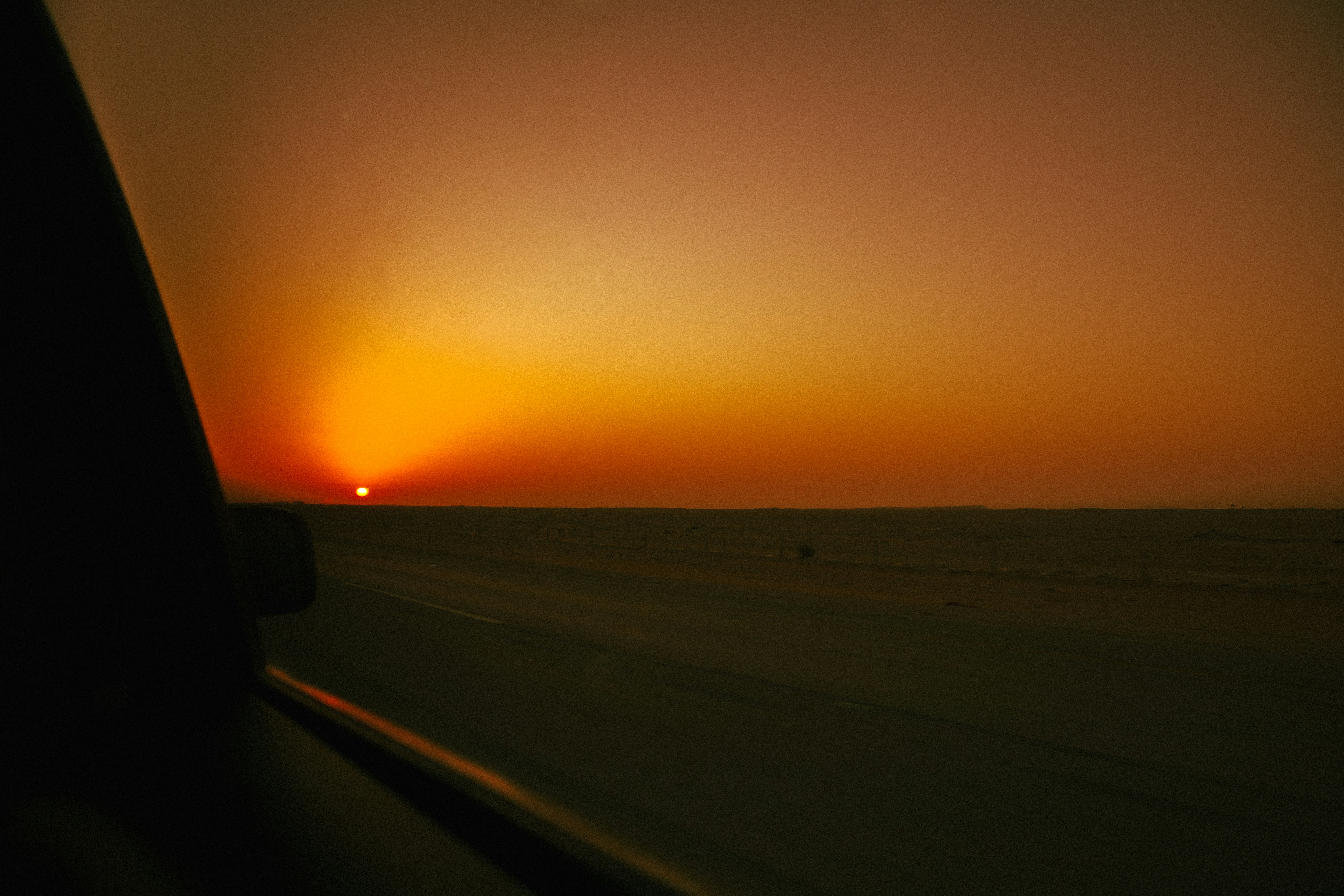 Desert Sunset Through a Car Window: Ember Horizon