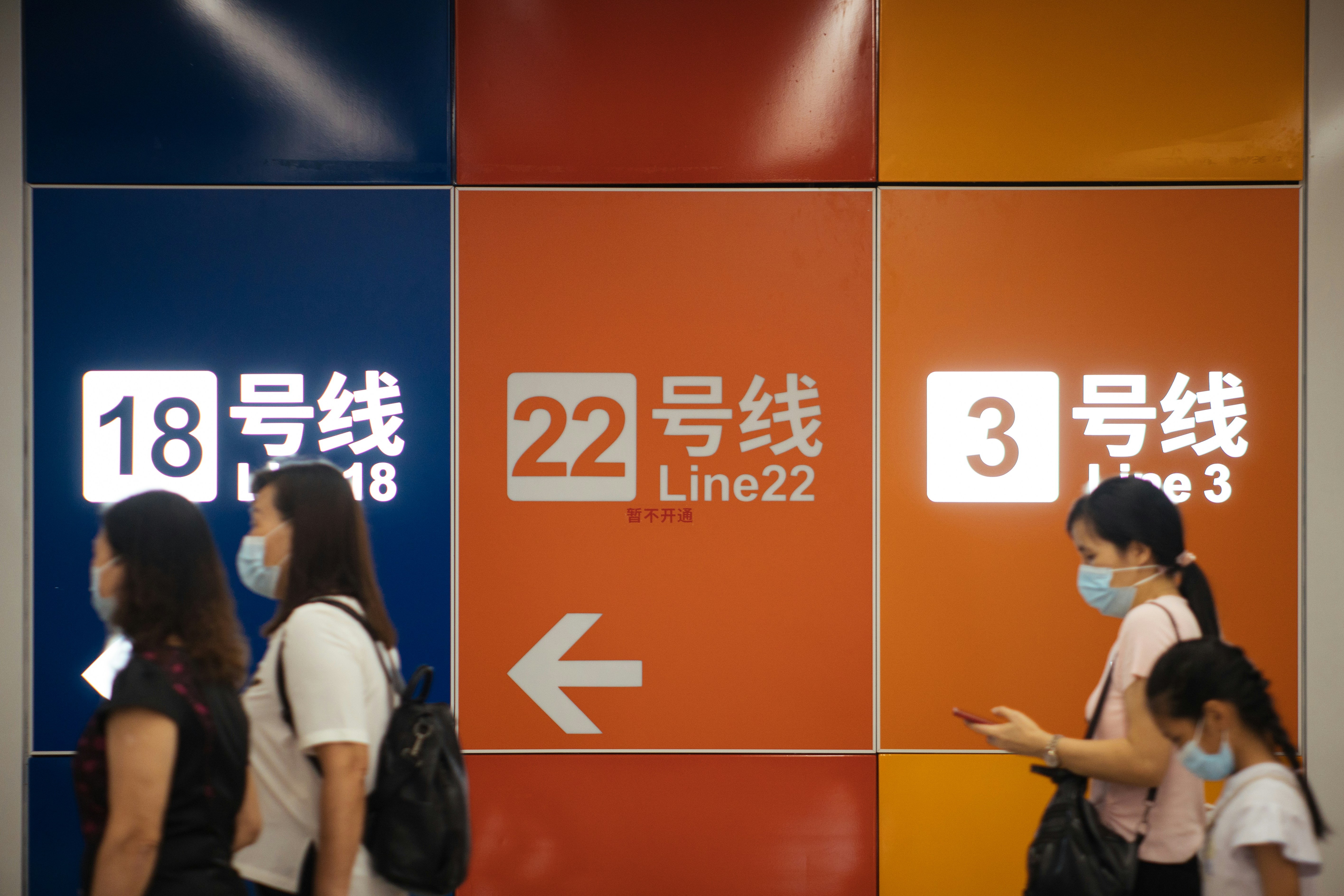 a group of people standing in front of a sign