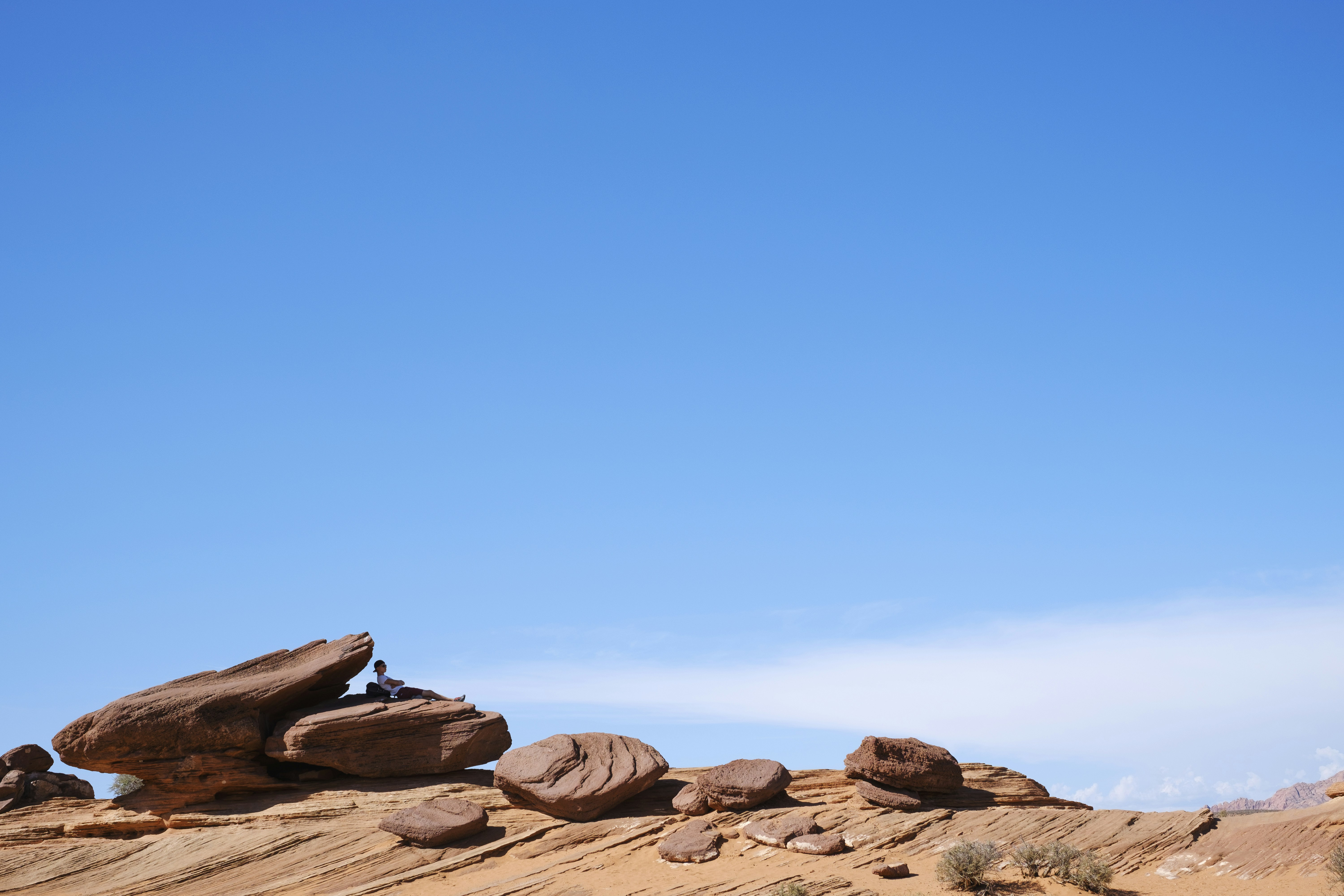 A rock formation in the middle of a desert photo – Free Man under ...