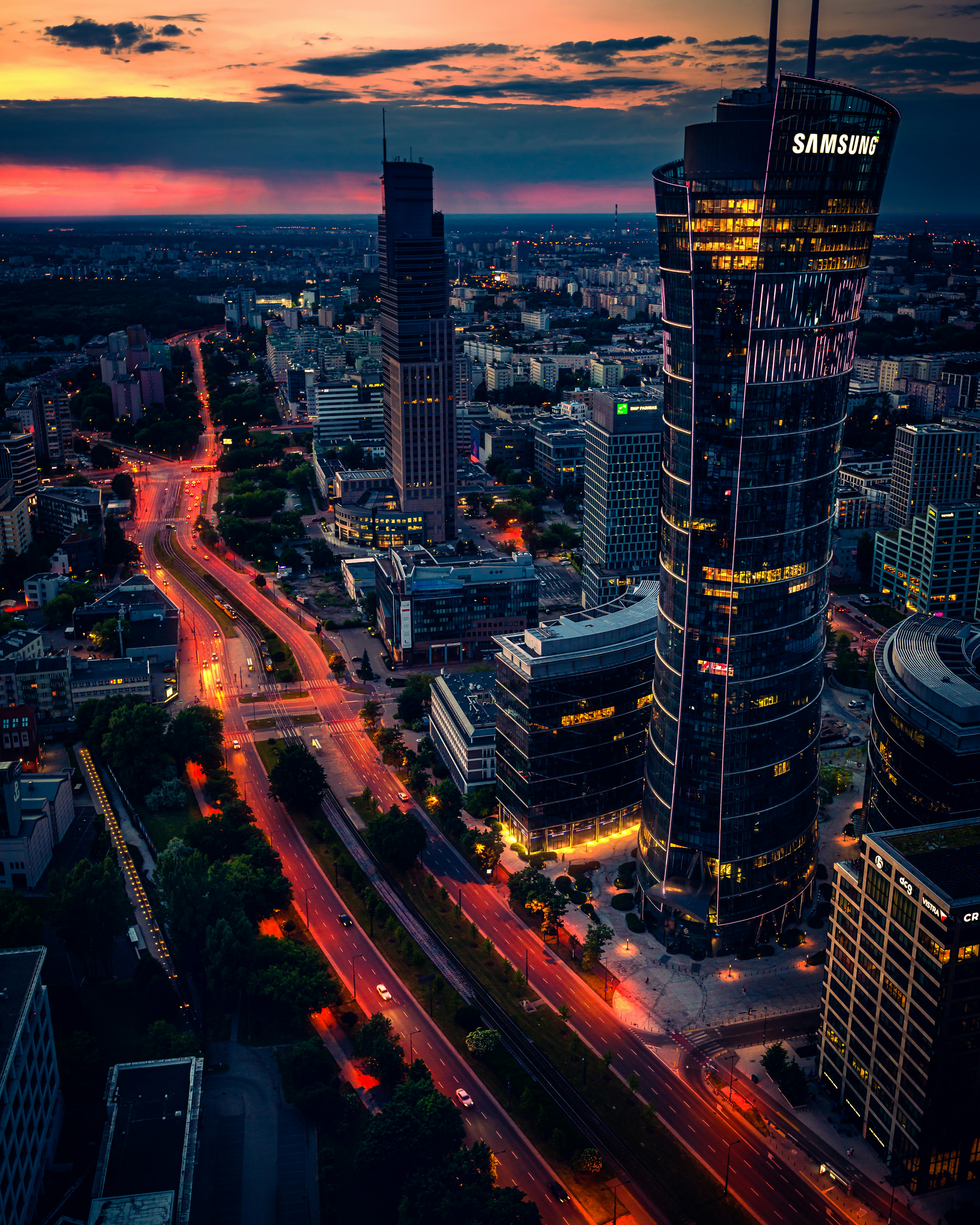 Crown of Glass and Neon Ribbons: Dusk Over a Modern City