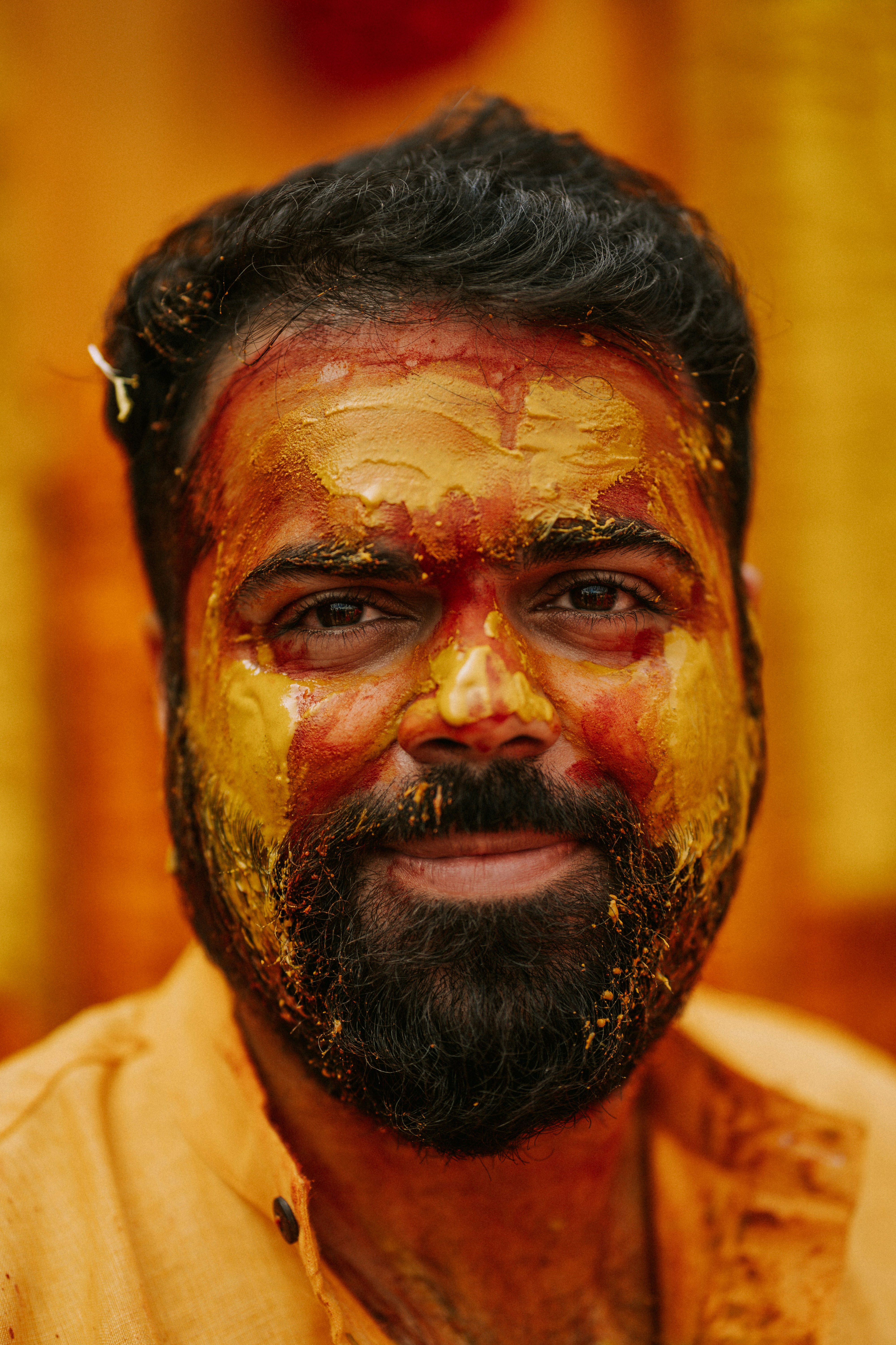 A man with yellow and red paint on his face photo – Free Kolkata Image ...