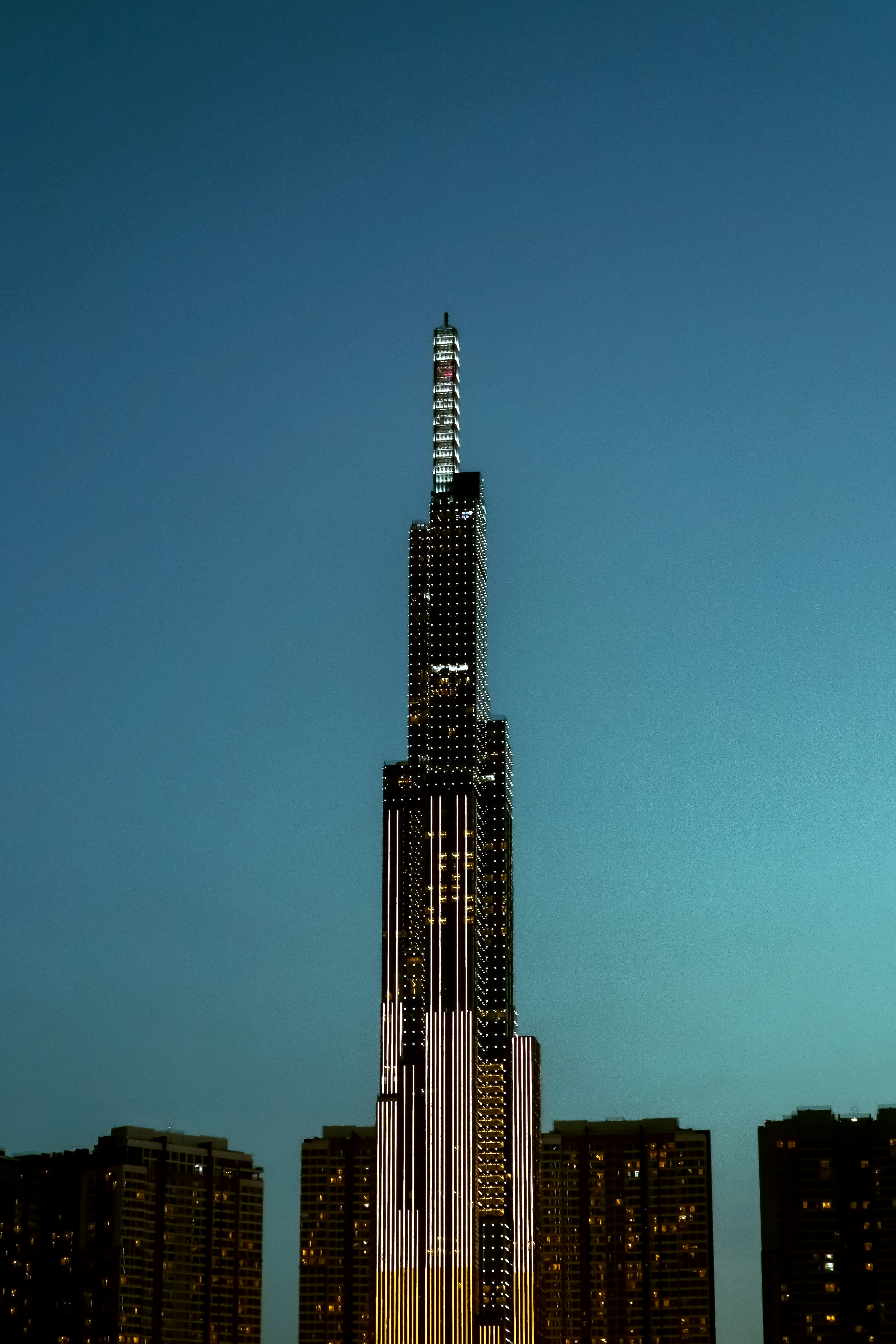 Neon Spine at Dusk: A Skyward Thread Through the City