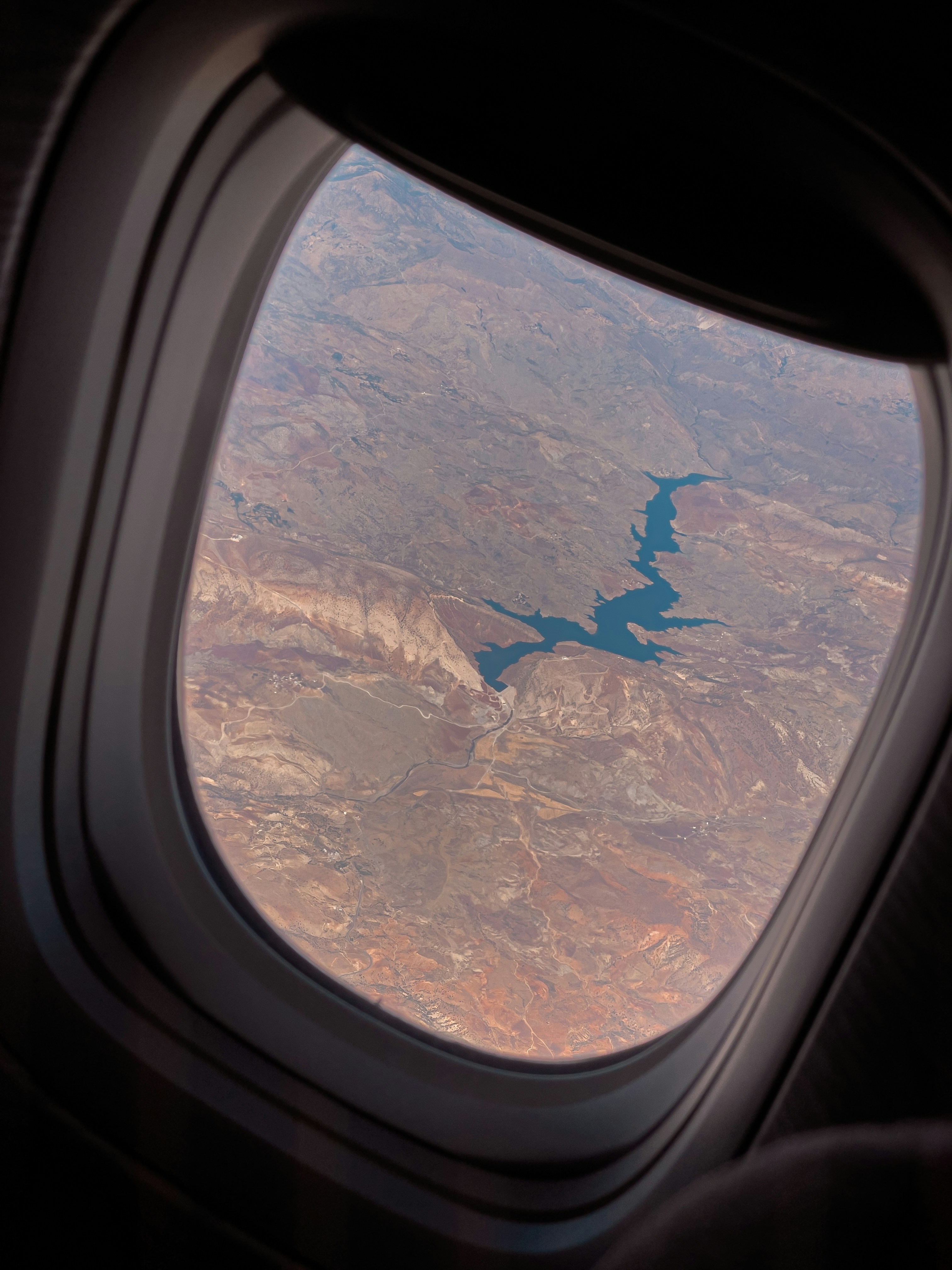 Azure Ribbon over Desert Valleys: An Aerial Window View