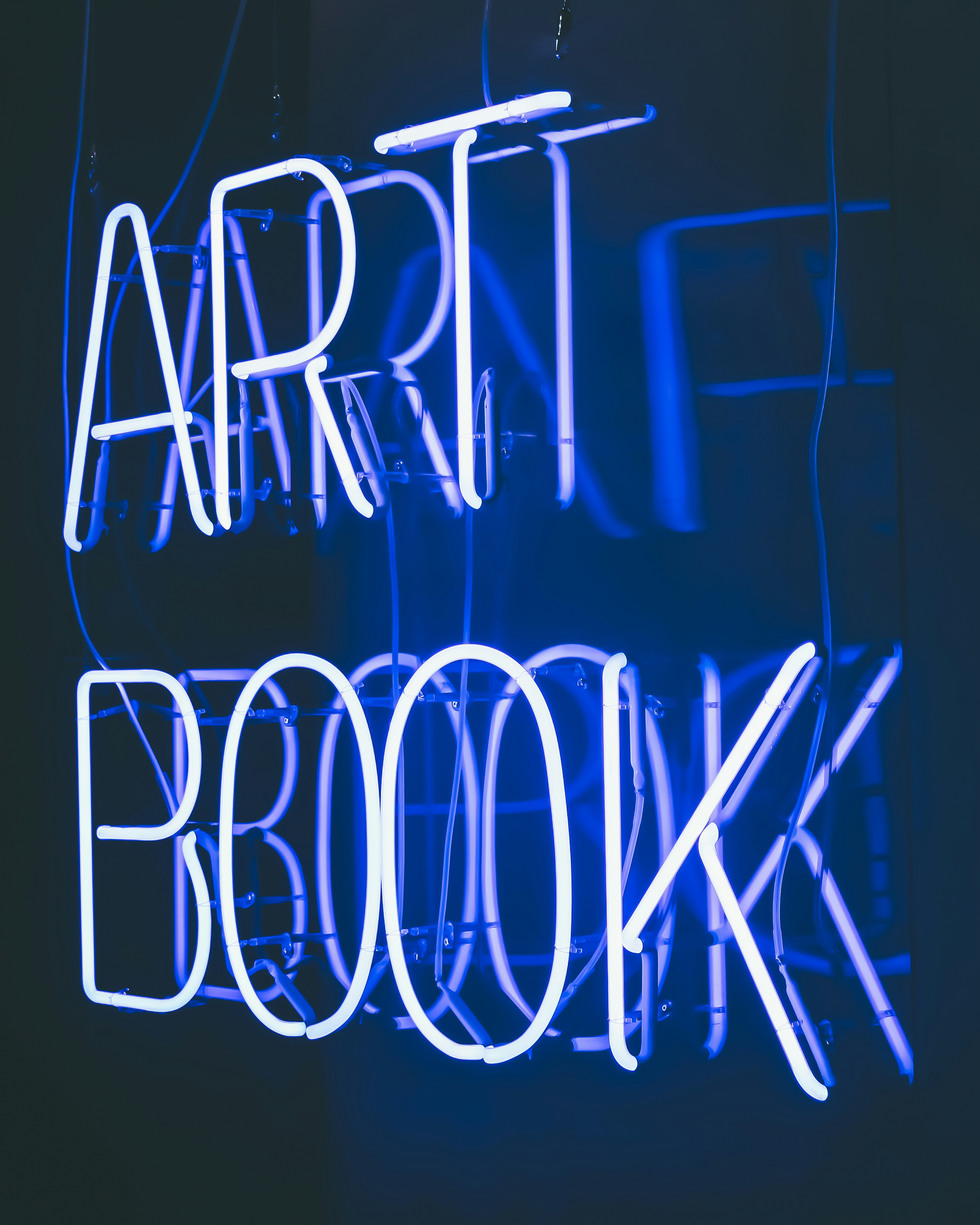 Blue Neon Words in a Dark Studio