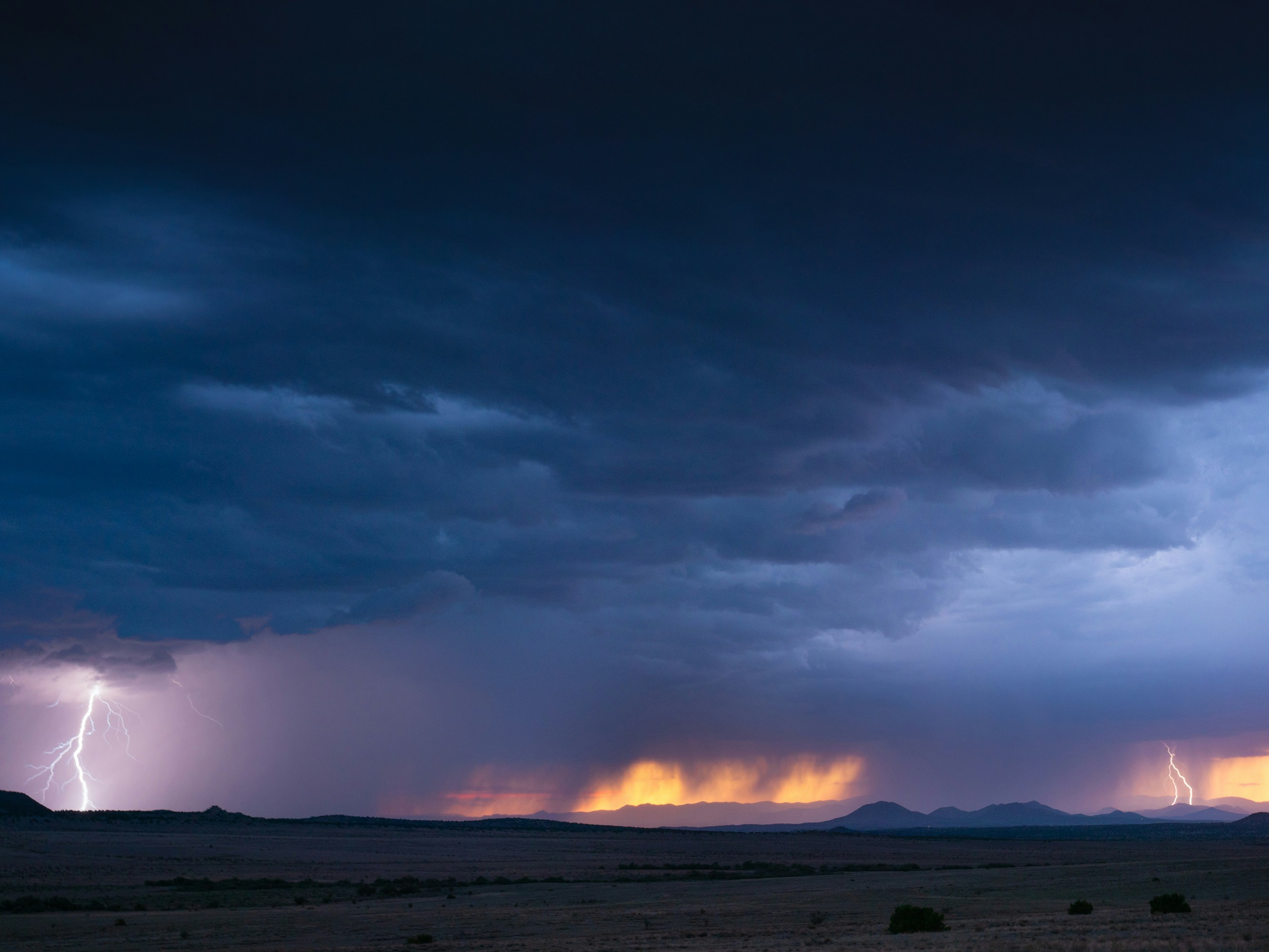 A lightning storm is seen in the distance photo – Free Blue Image on ...