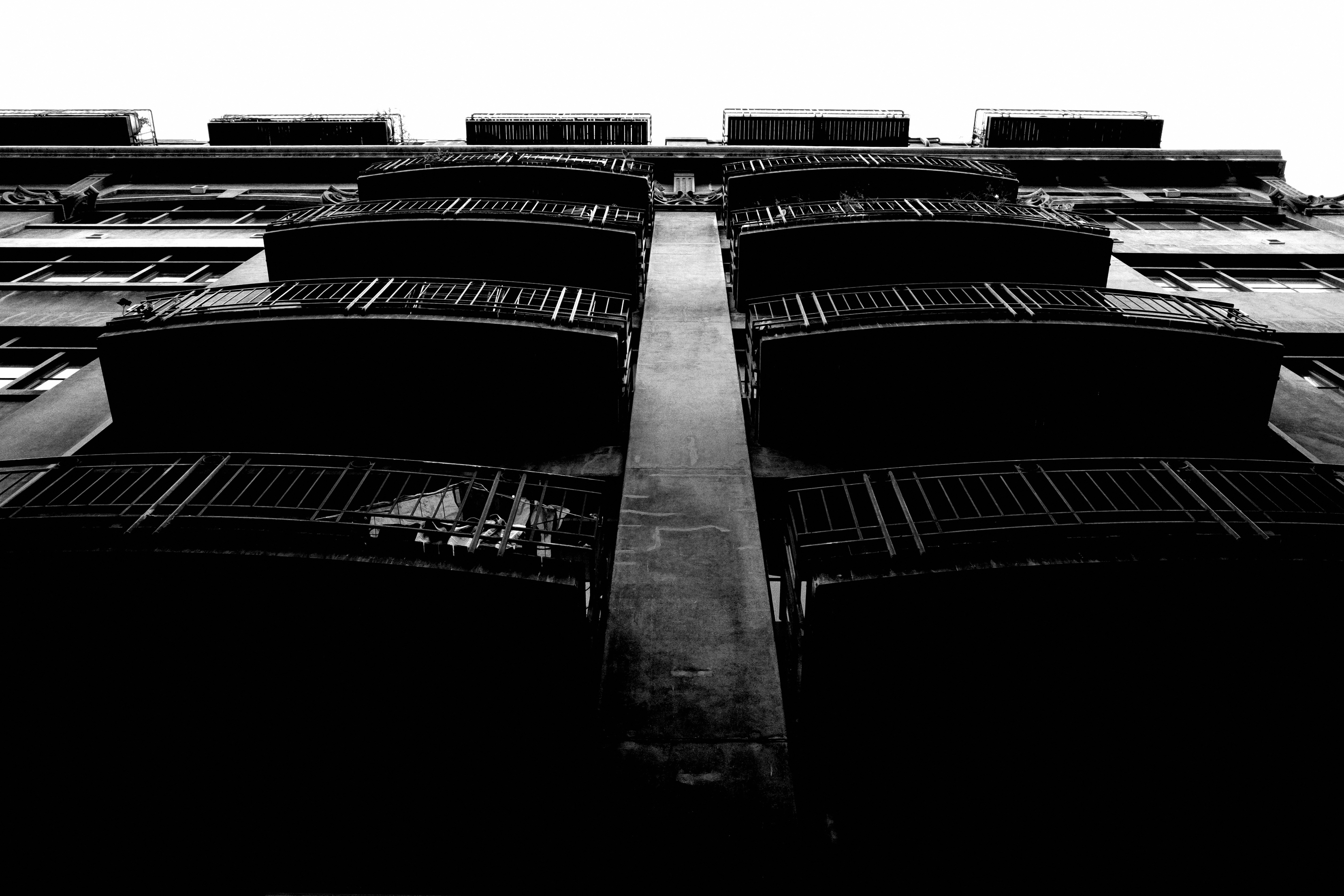 a black and white photo of a building with balconies