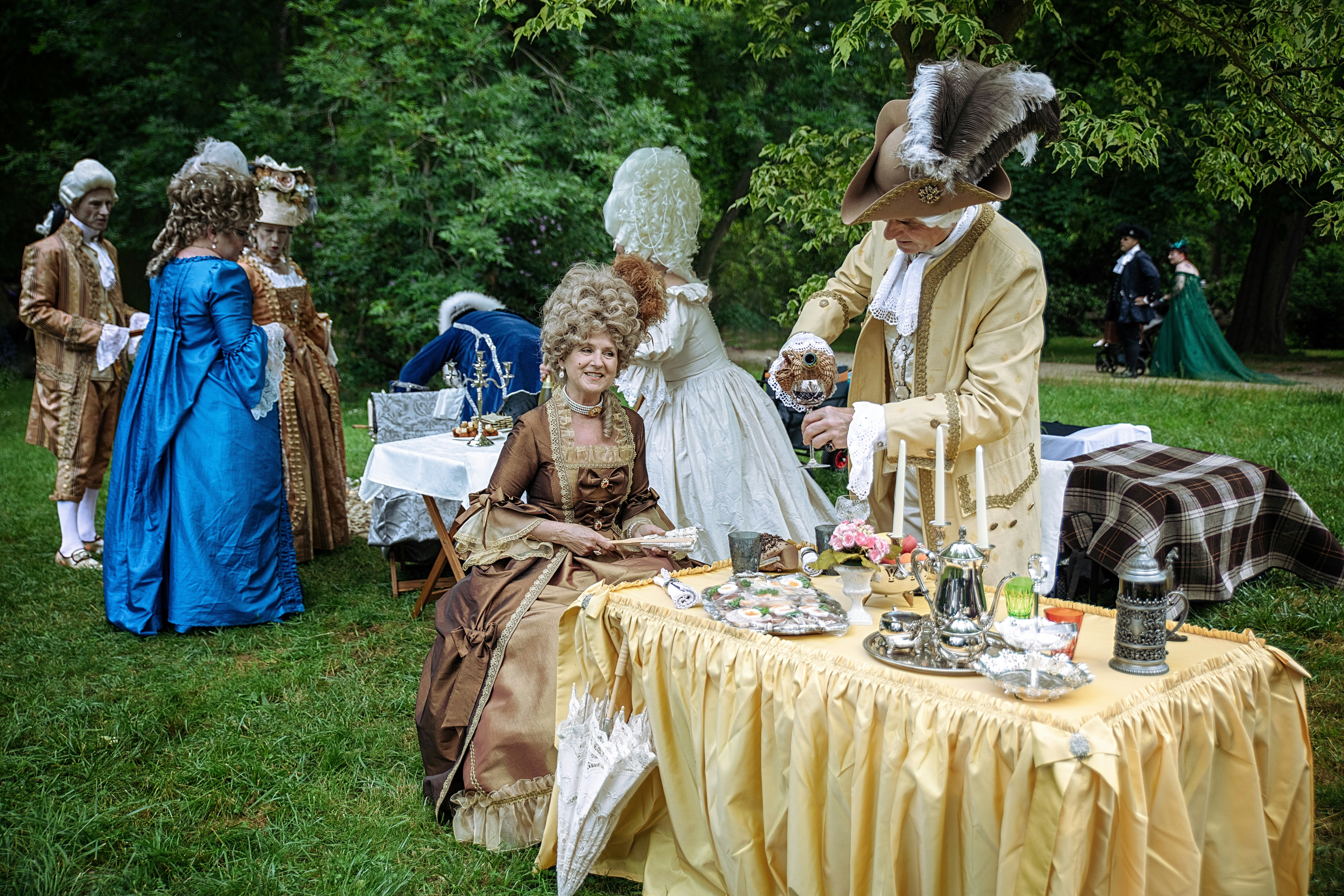 A group of people dressed in period costumes at a tea party photo ...
