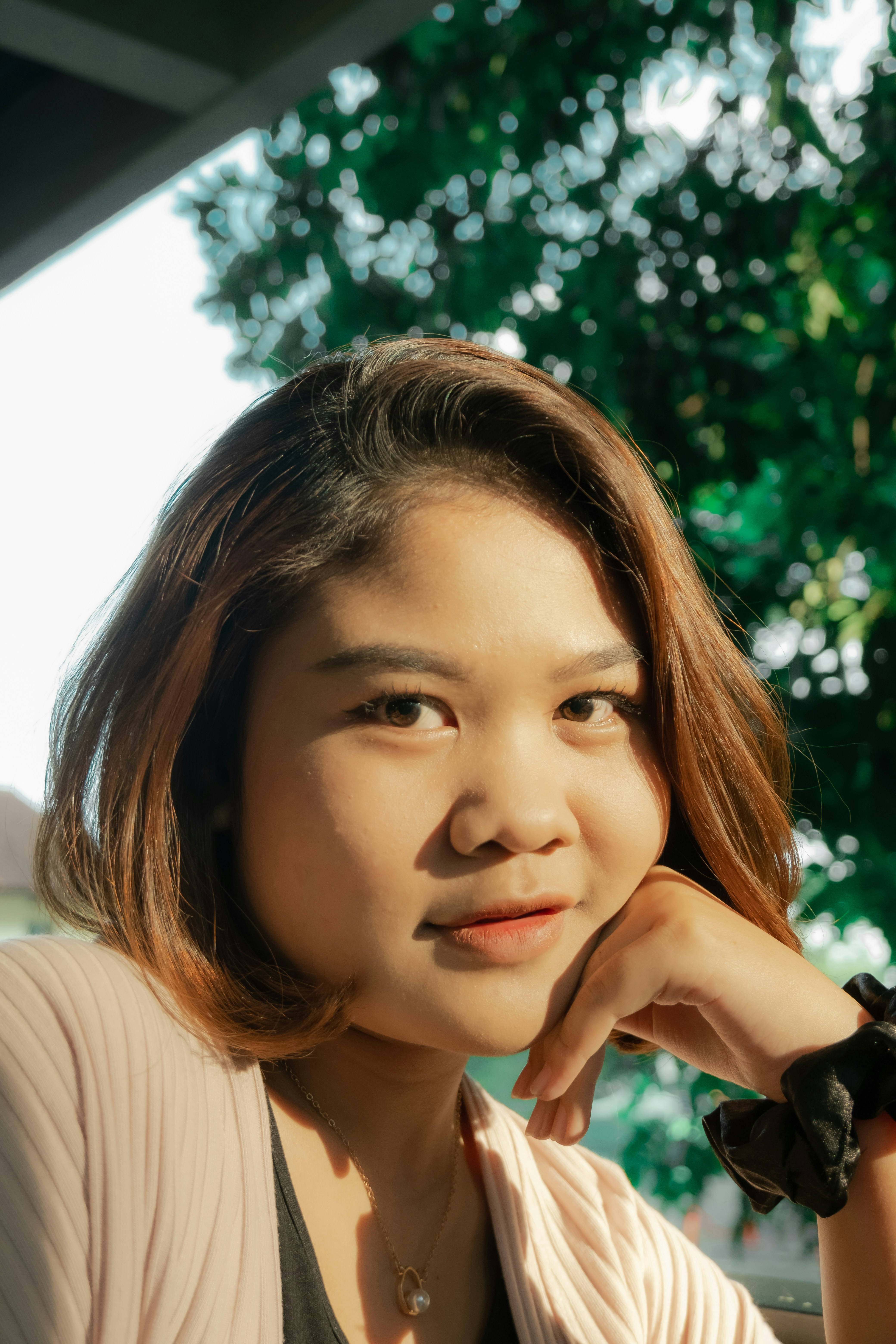 A woman sitting down with her hand on her chin photo – Free Kopi tahura ...