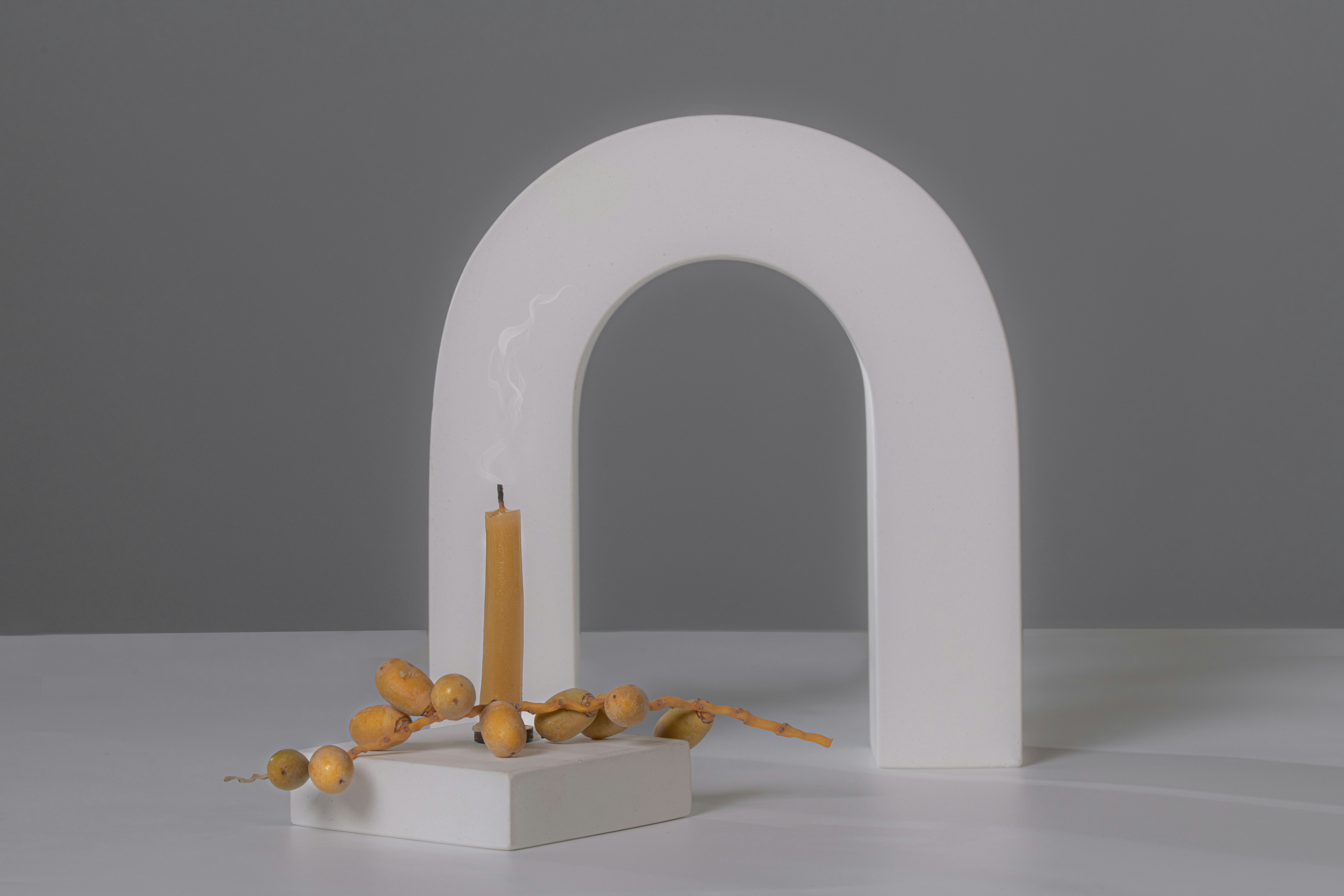 Minimal Still Life: Neon Arch, Candle, and Golden Berries on White Studio