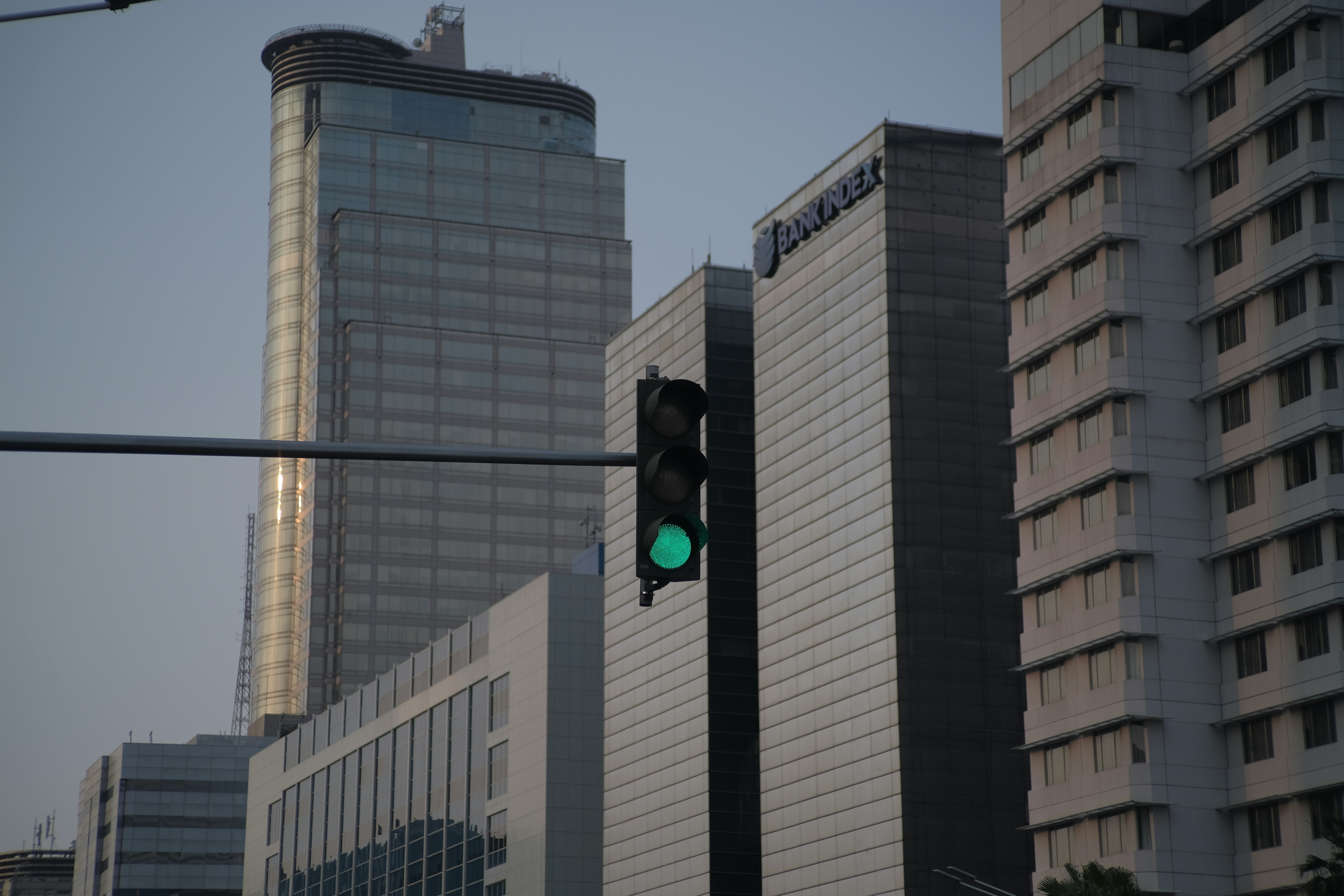 A green traffic light in front of tall buildings photo – Free ...