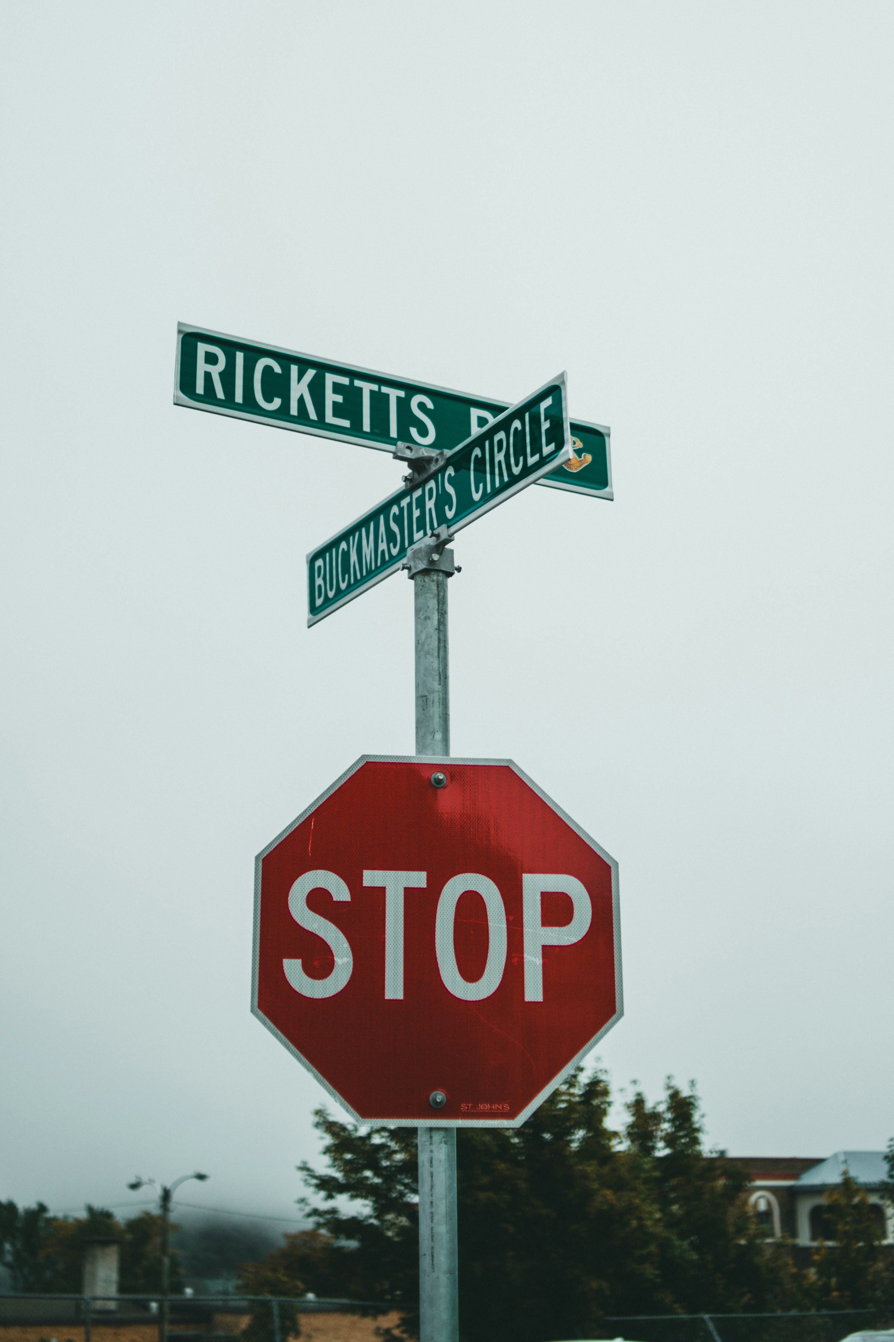 A stop sign with two street signs on top of it photo – Free Brown Image ...