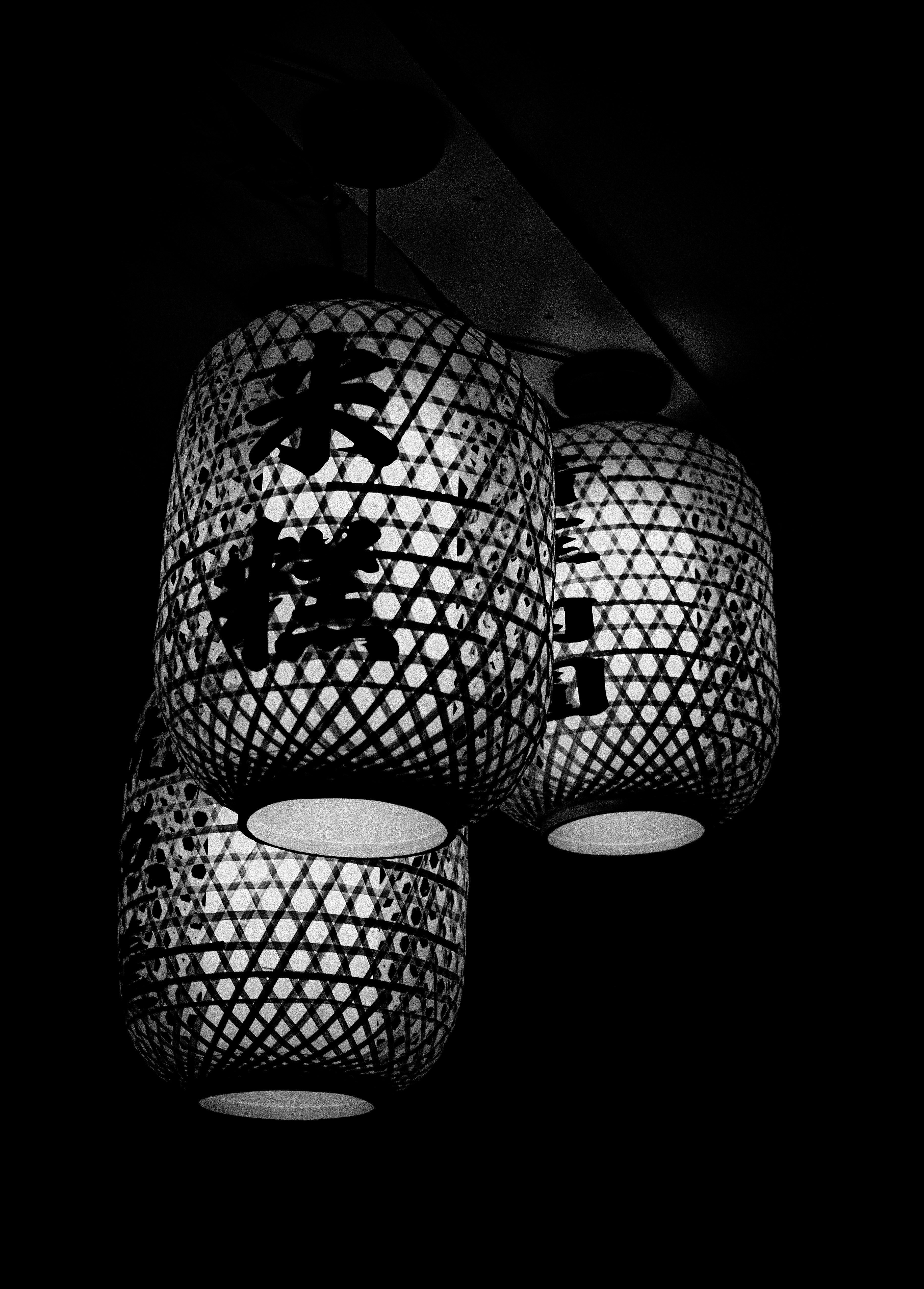 Lanterns in shadow: patterned glow against a velvet night