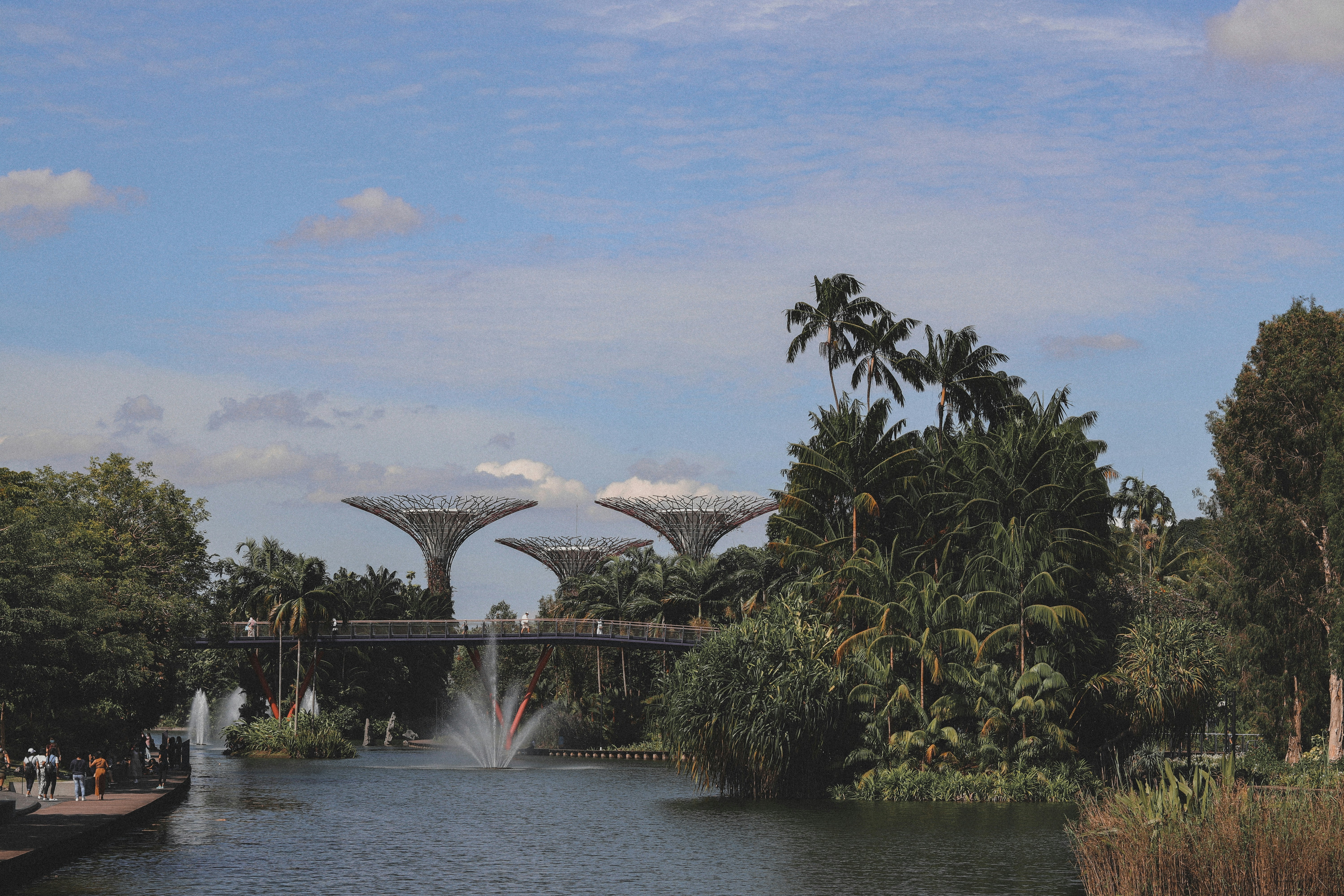 Futuristic structures rise above lush greenery, reflecting the blend of technology and nature in a serene urban landscape.