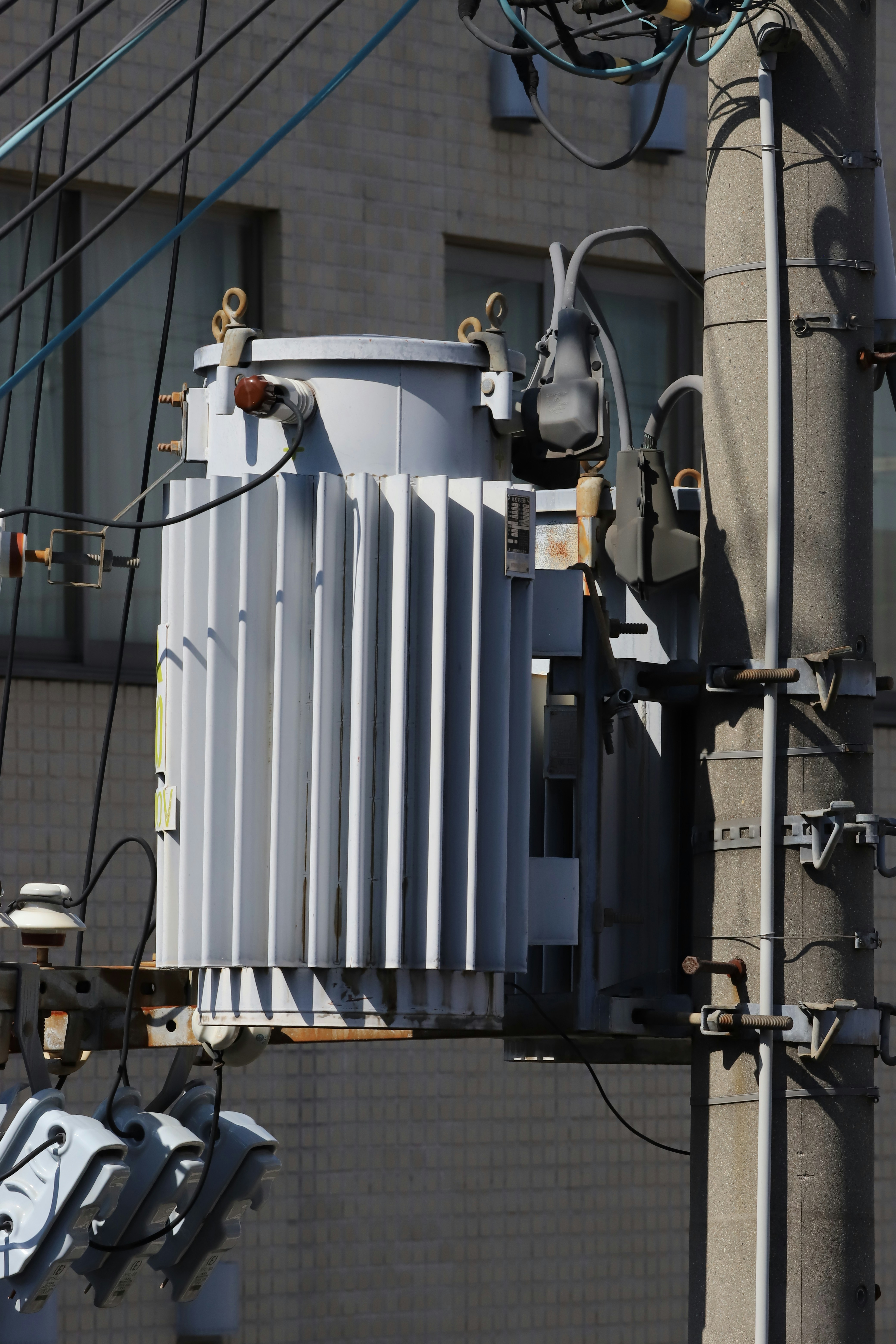 Ribbed Transformer Amid Urban Electric Lines