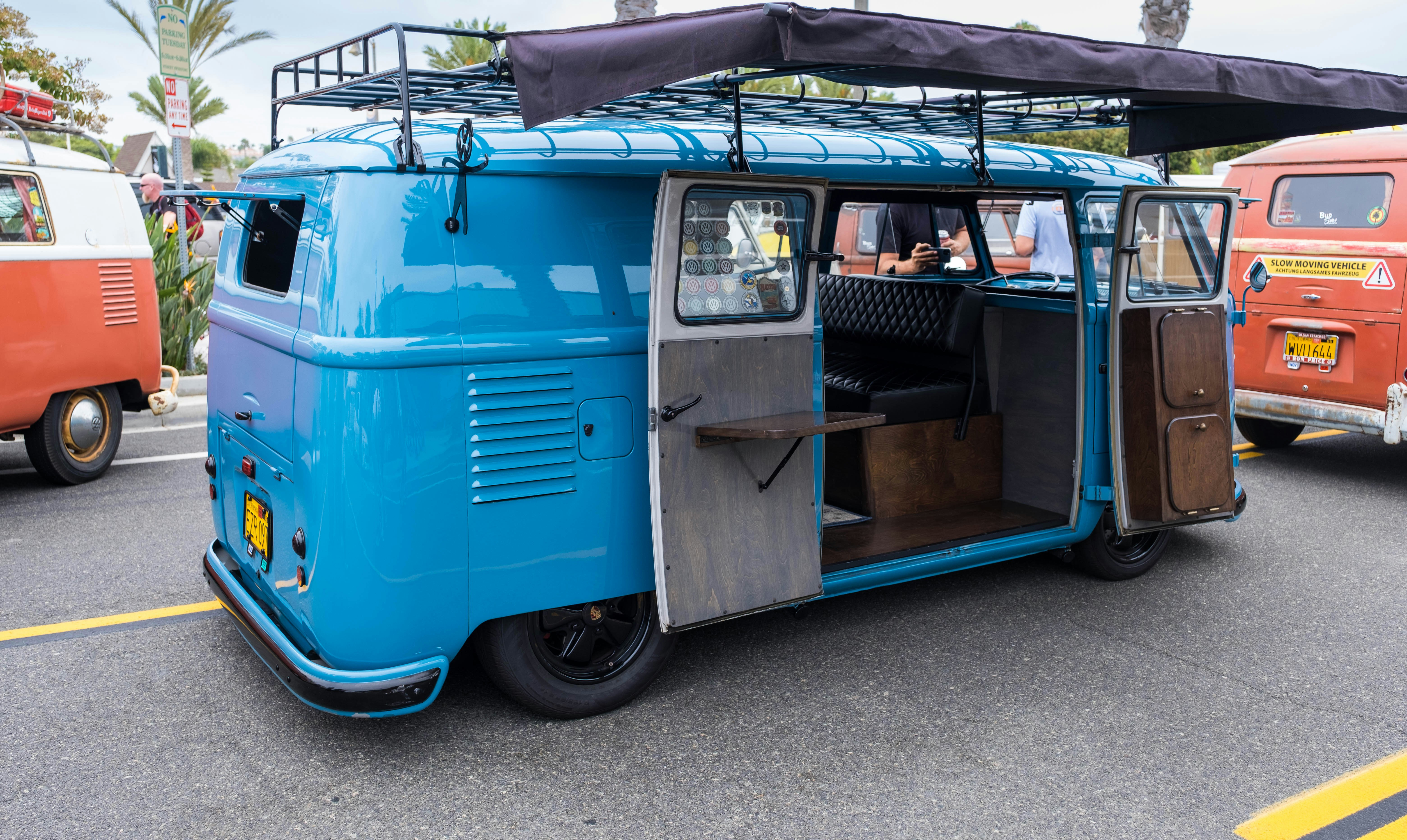 A small blue van with a roof rack on the back of it photo – Free Usa ...